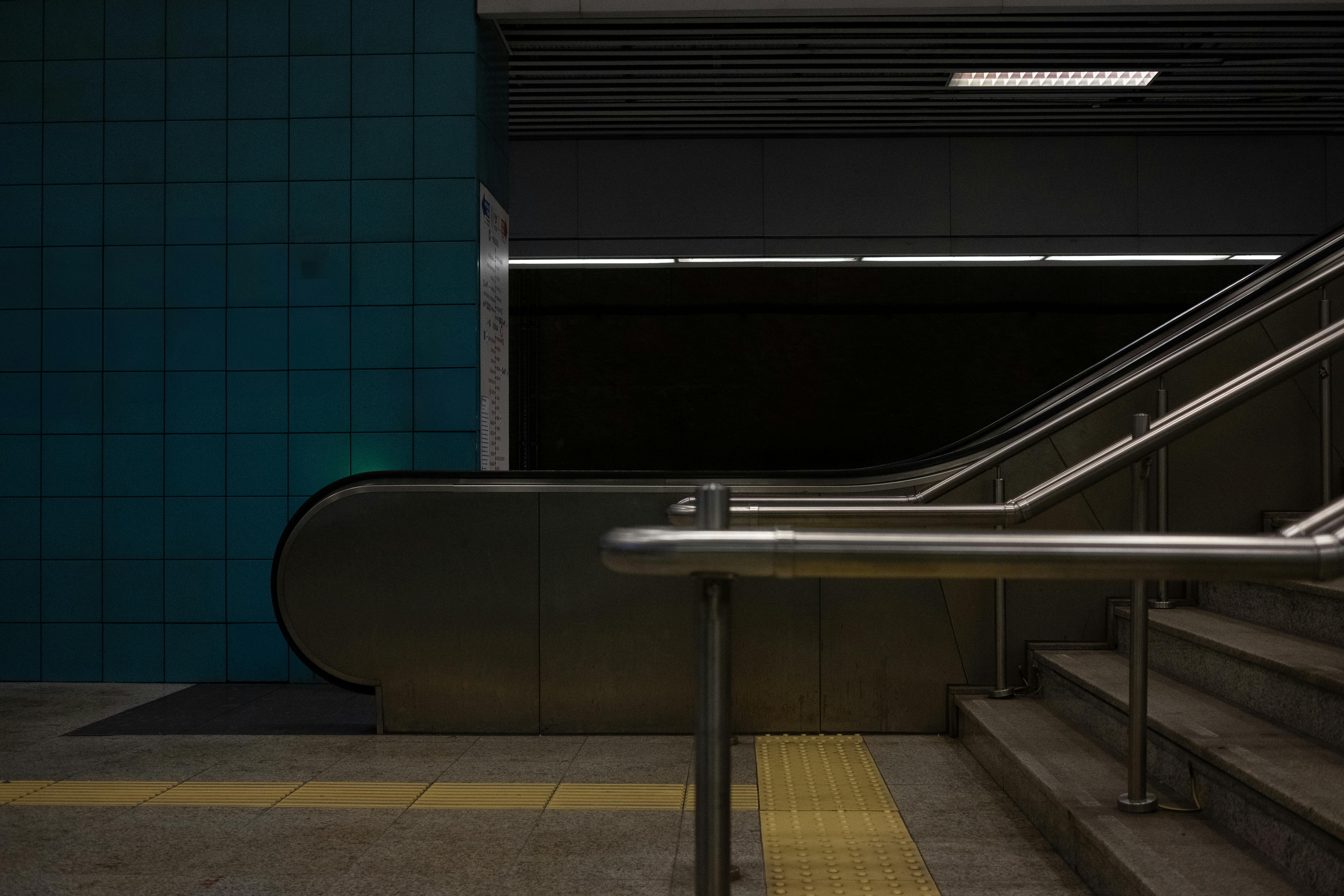 A subway station with stairs and a metal railing · Free Stock Photo