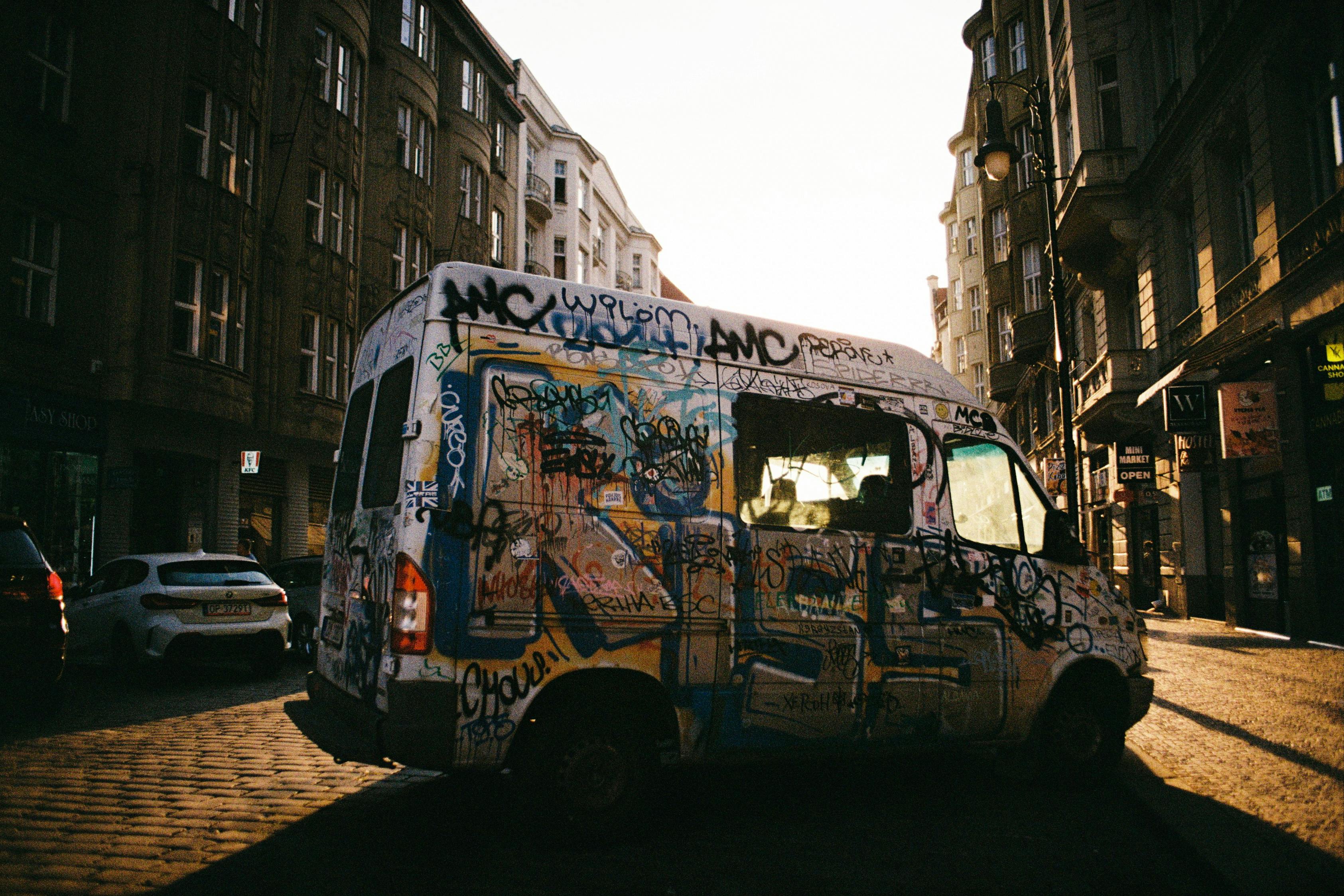 A van with graffiti on it parked on a street · Free Stock Photo