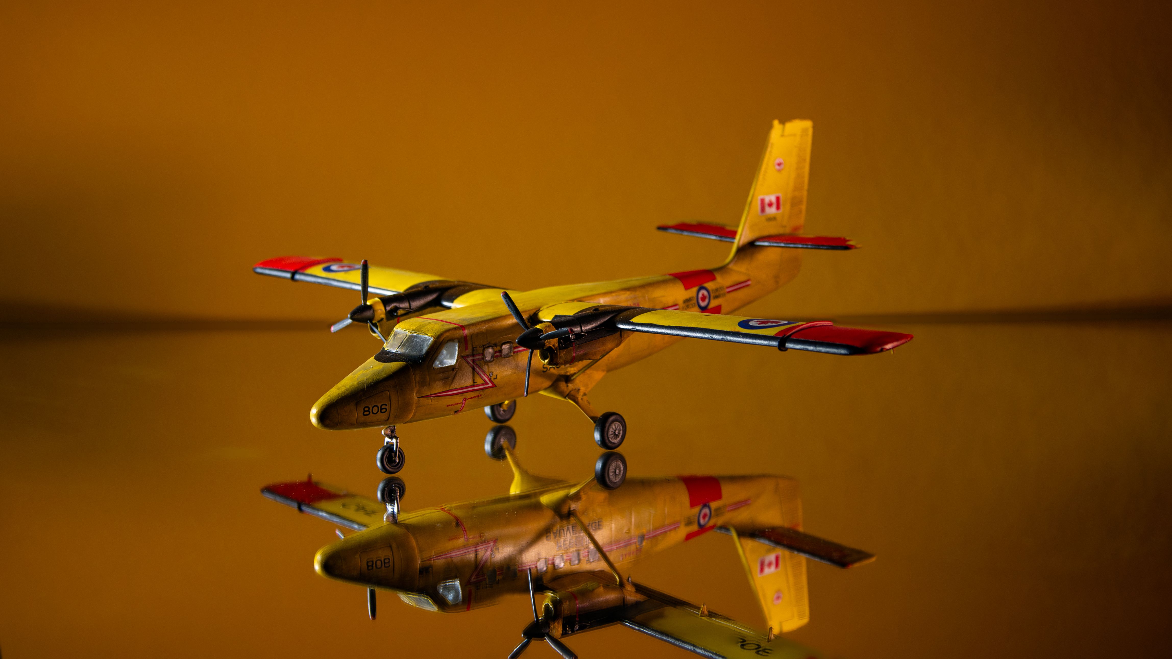 A small model airplane is sitting on a table · Free Stock Photo