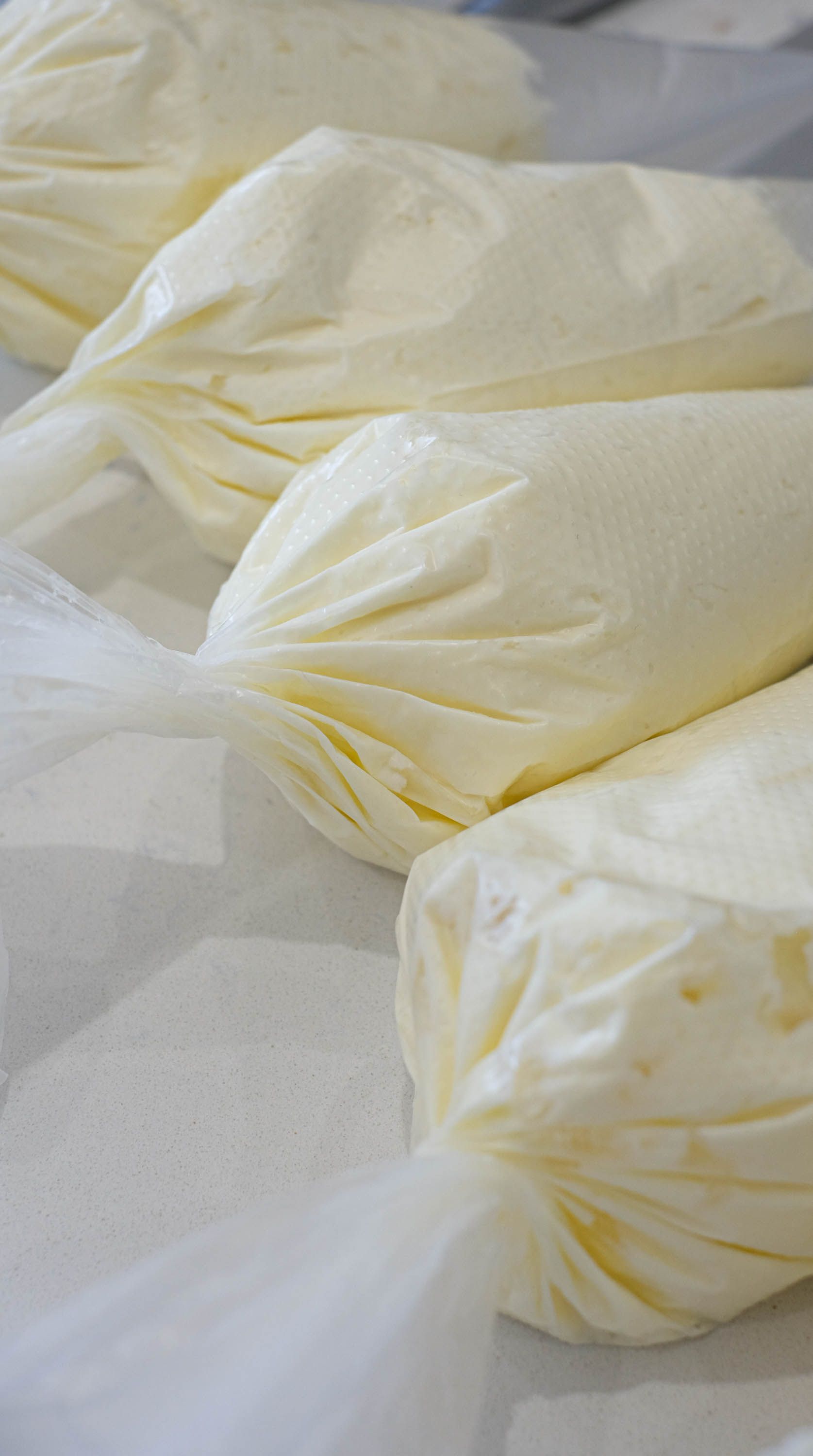 A bunch of butter wrapped in plastic bags · Free Stock Photo