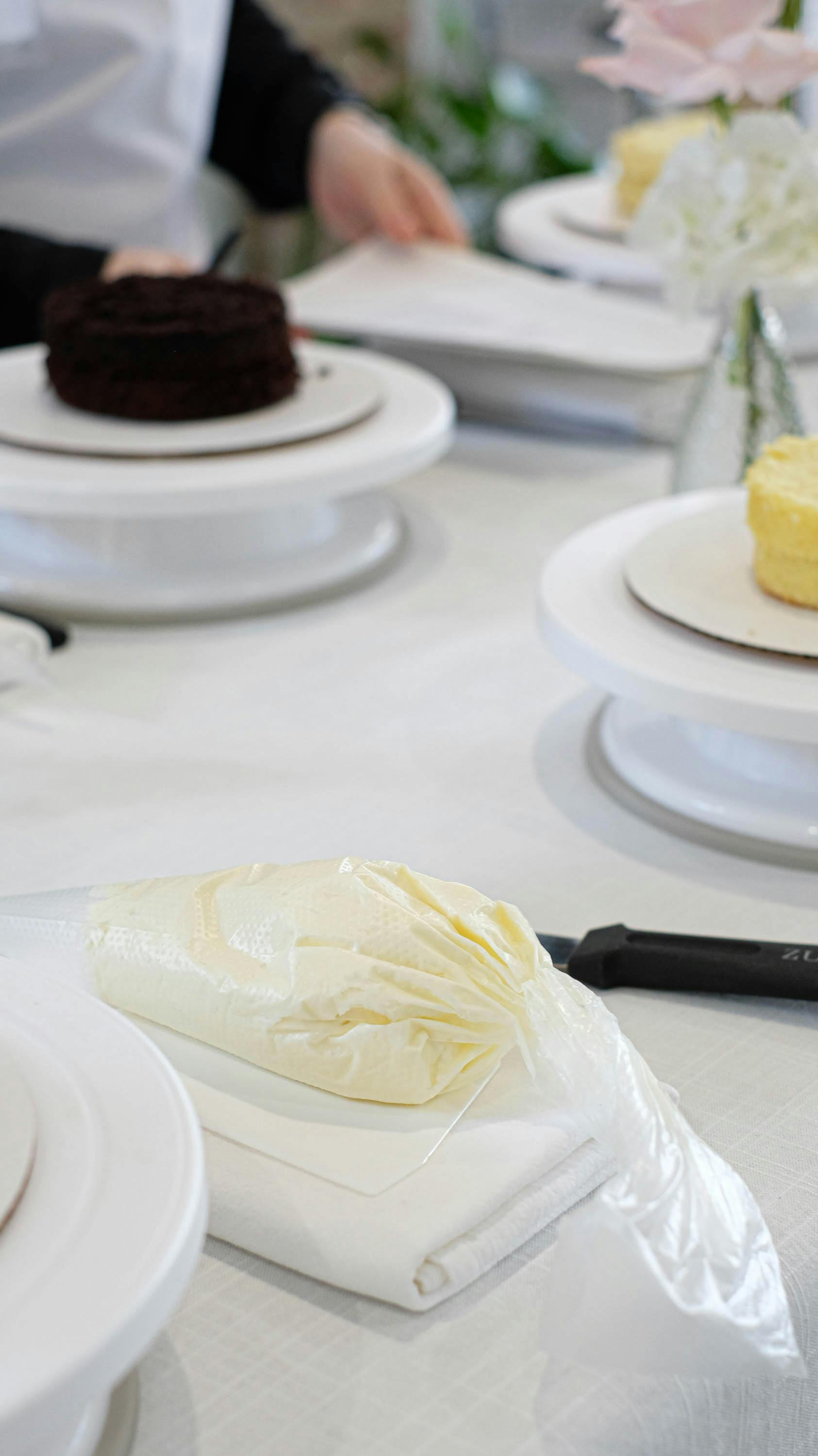 A table with several cakes and plates on it · Free Stock Photo