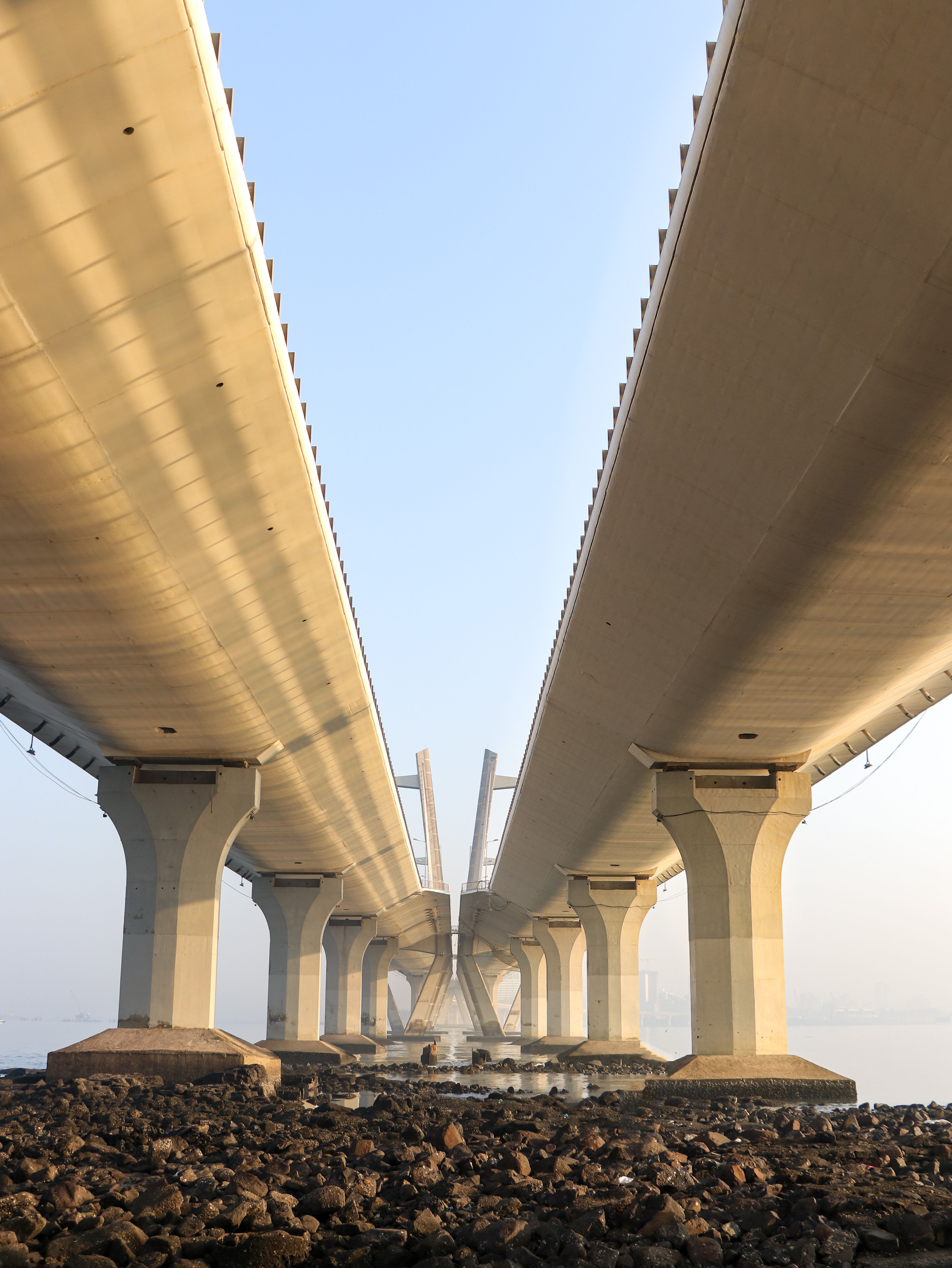 The bridge is over the water and has a long span · Free Stock Photo