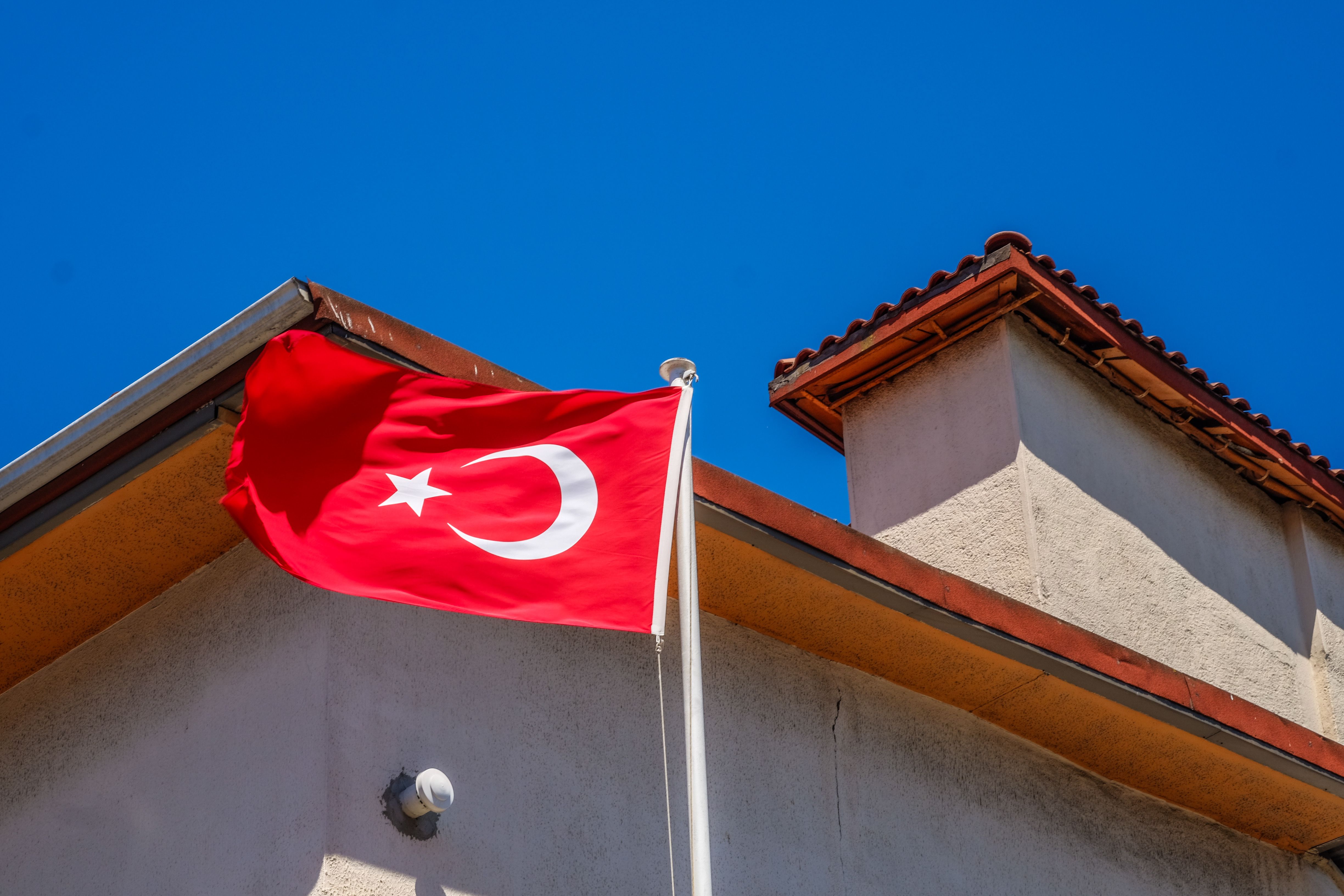 Turkey's flag flying in front of a house · Free Stock Photo