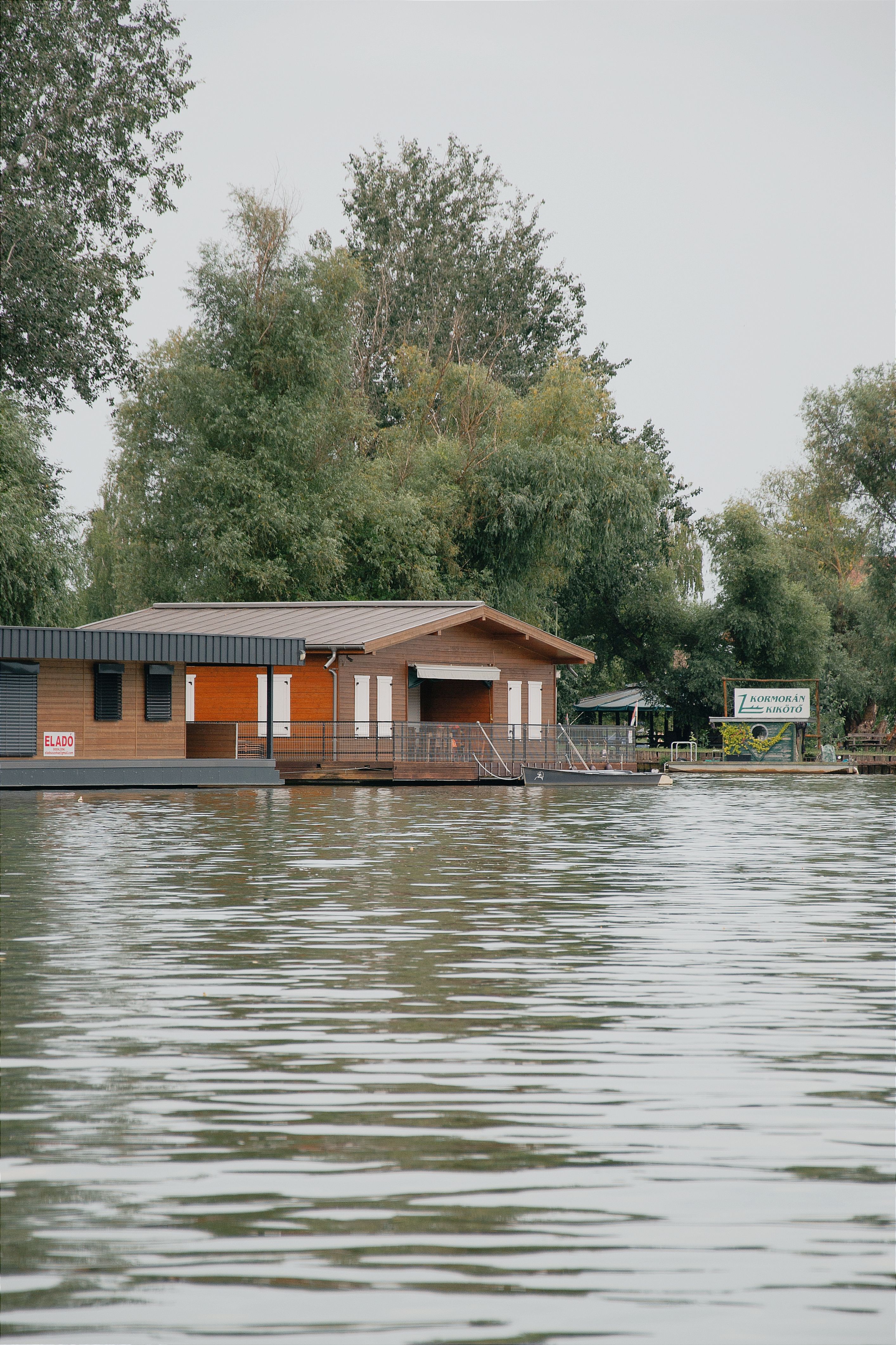 A houseboat on the water with a dock · Free Stock Photo