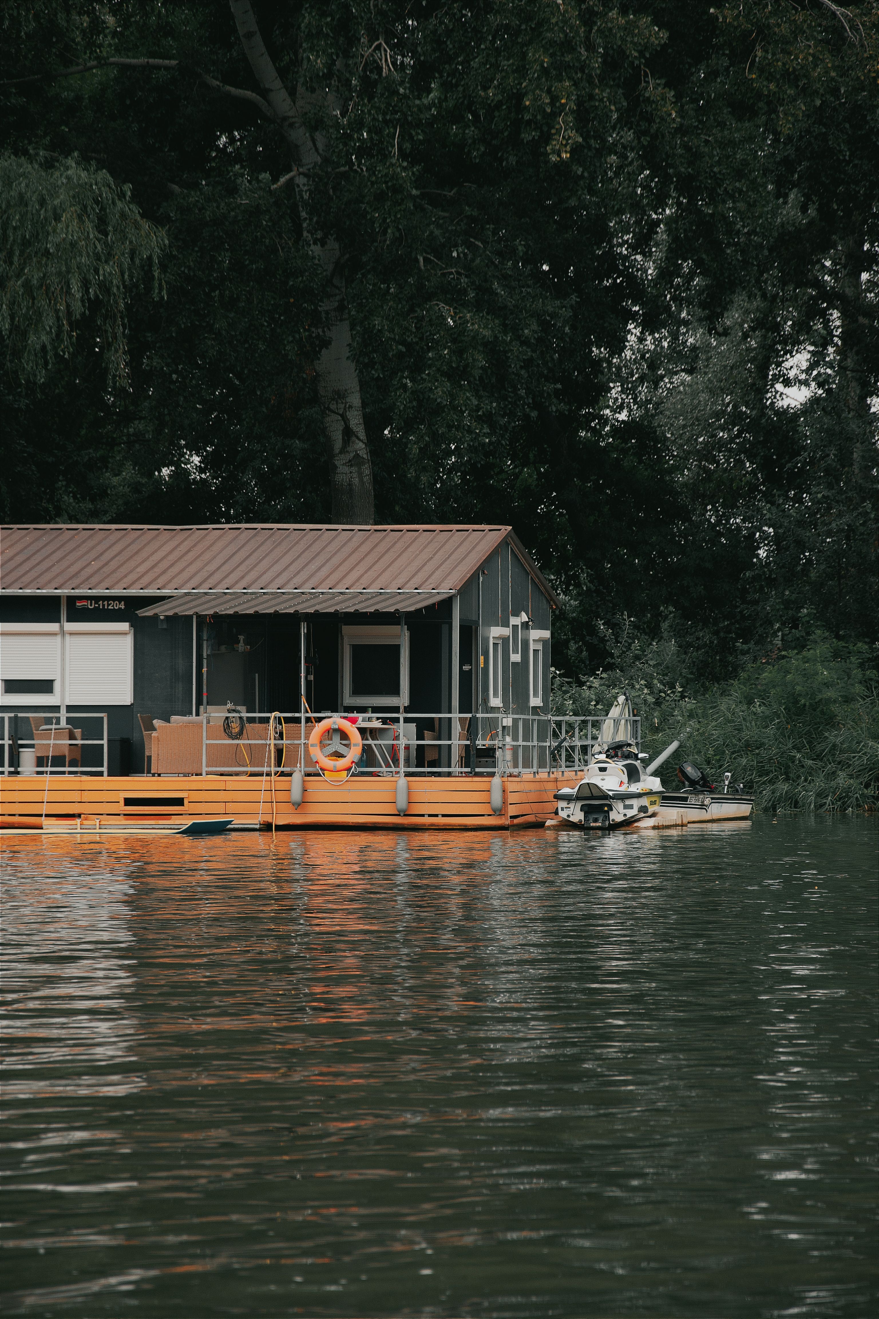 A houseboat on the water with a dock · Free Stock Photo