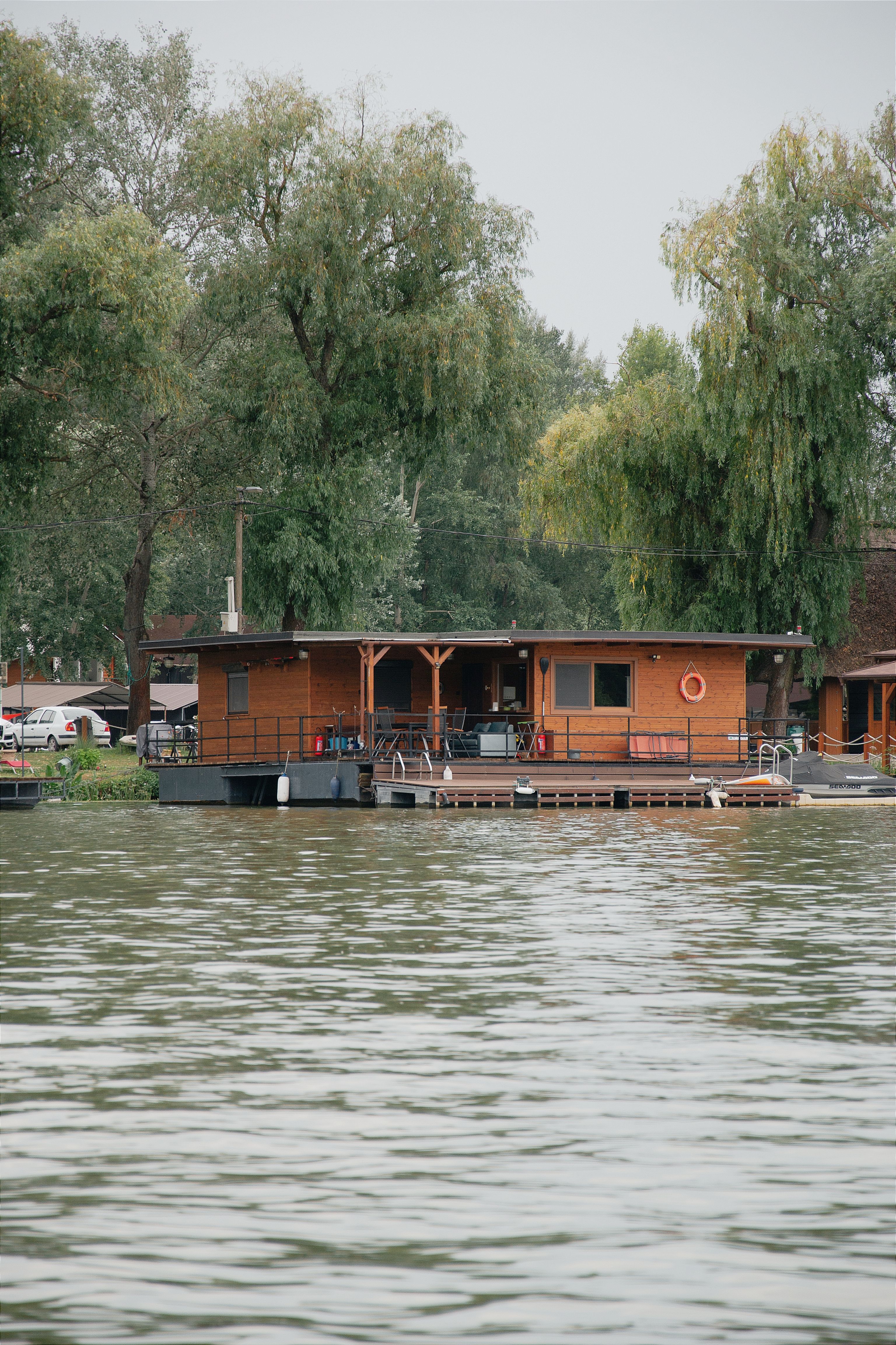 A houseboat on the water with a dock · Free Stock Photo