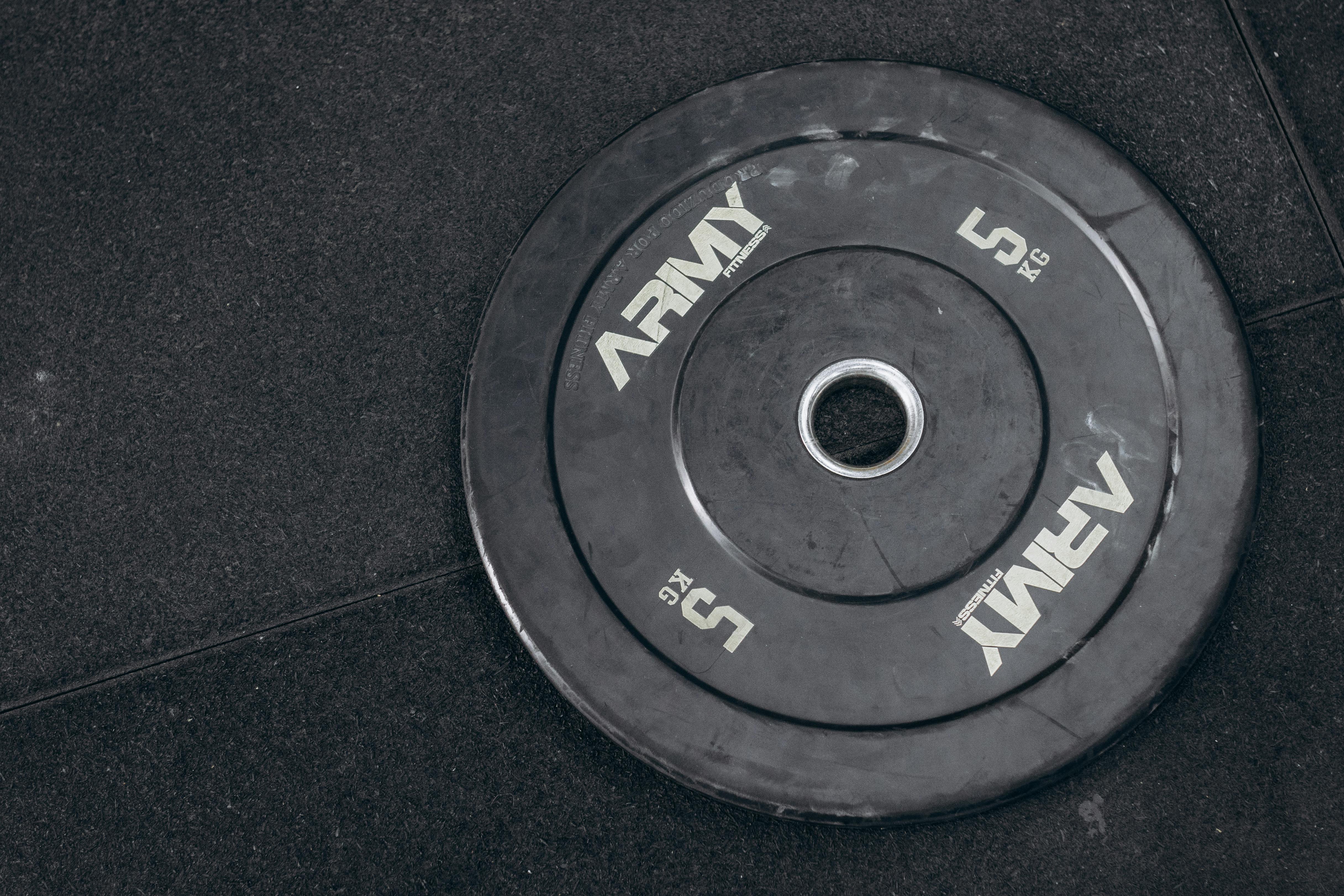 A black and white photo of a weight plate · Free Stock Photo