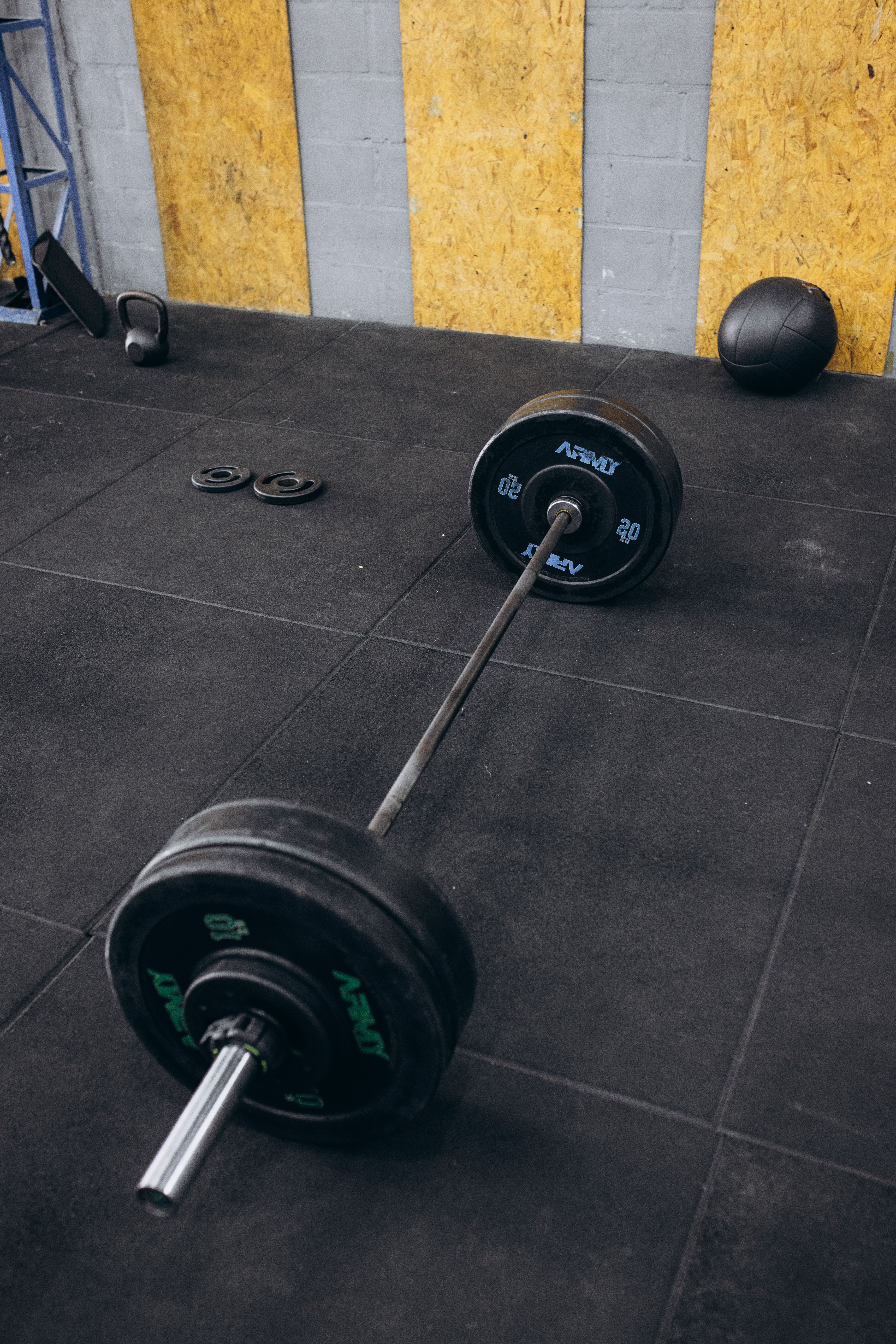 A barbell and weights on the floor in a gym · Free Stock Photo