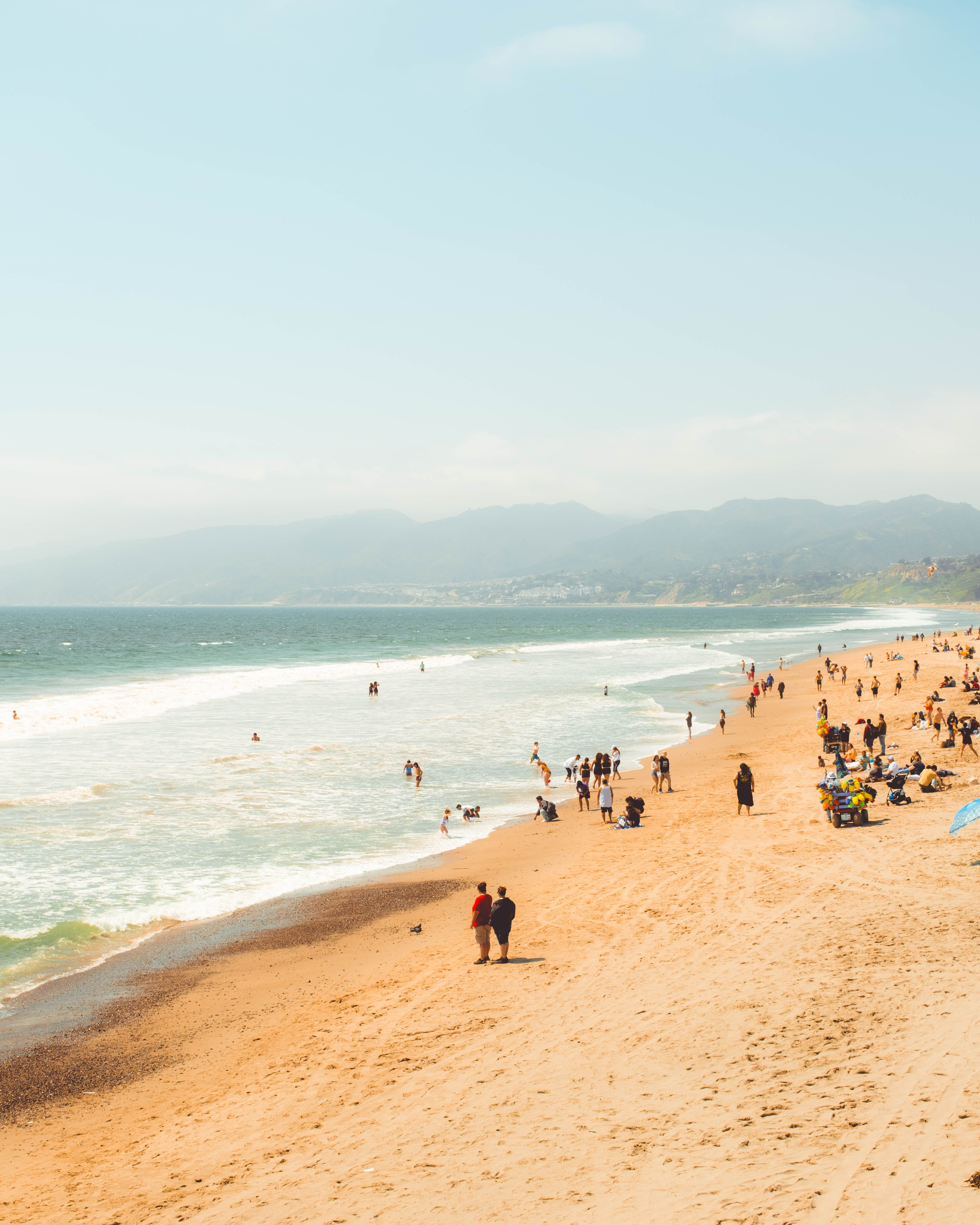 A beach with people walking on it and a sign that says, beach · Free ...