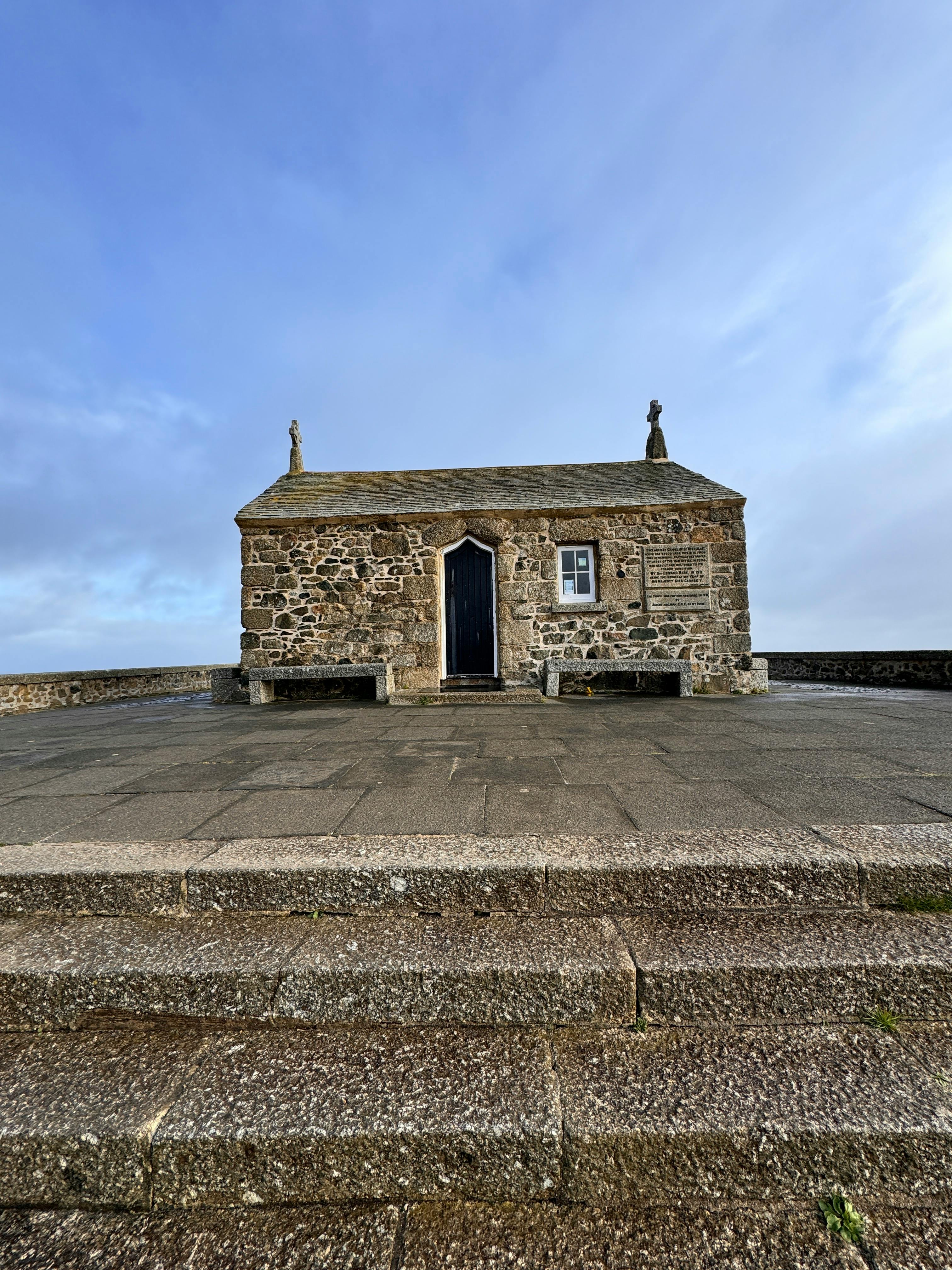 A small stone building on top of a hill · Free Stock Photo