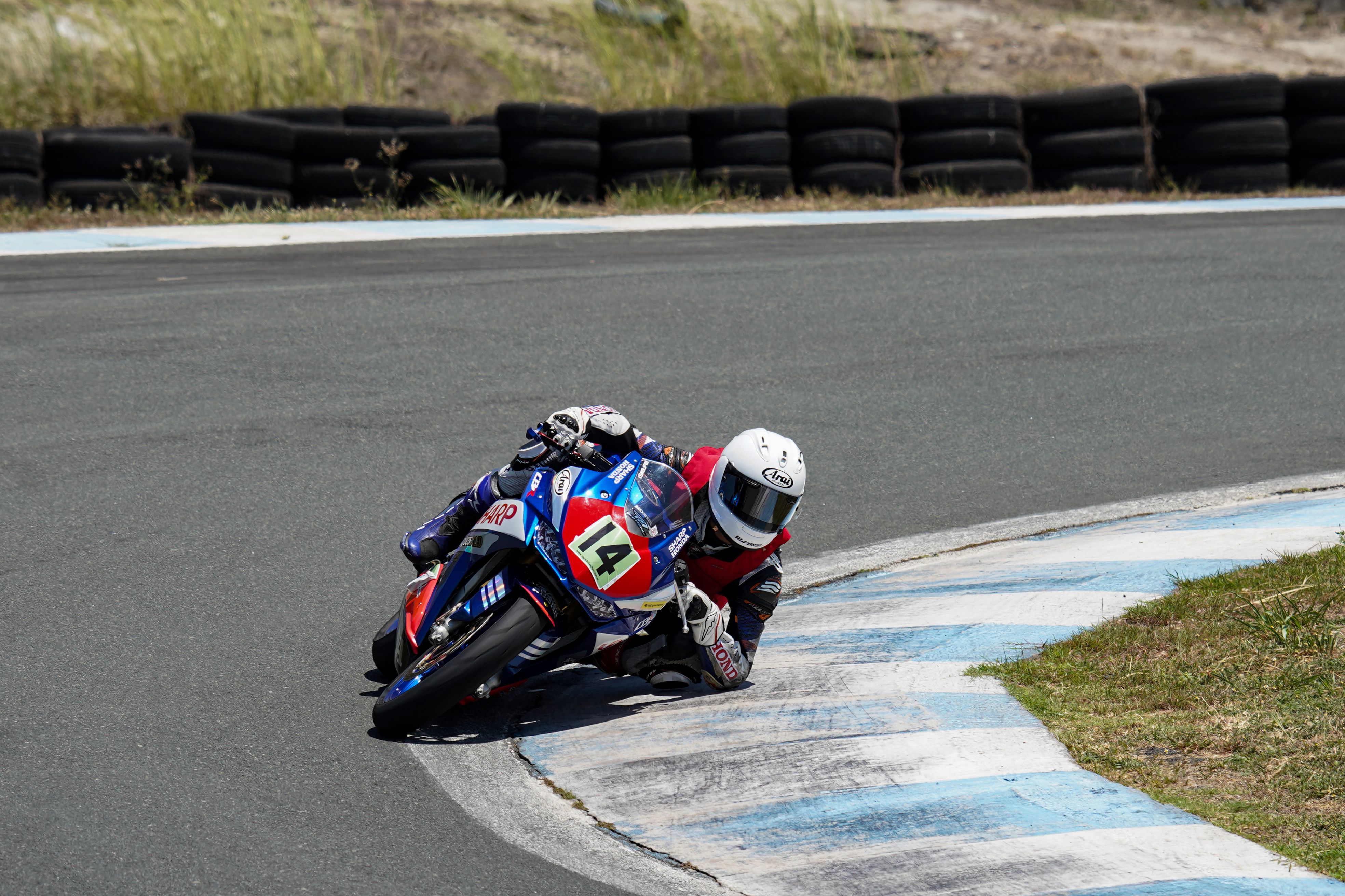 A person riding a motorcycle on a track · Free Stock Photo