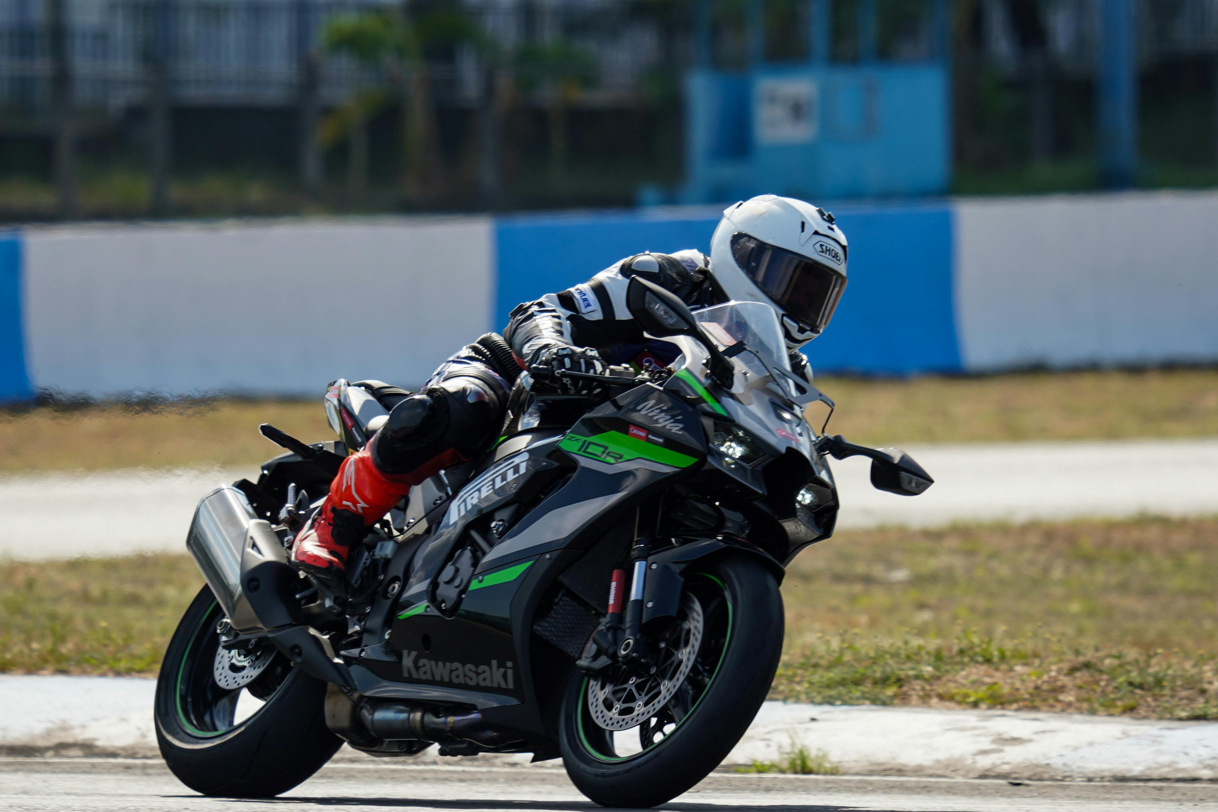 A person riding a motorcycle on a track · Free Stock Photo