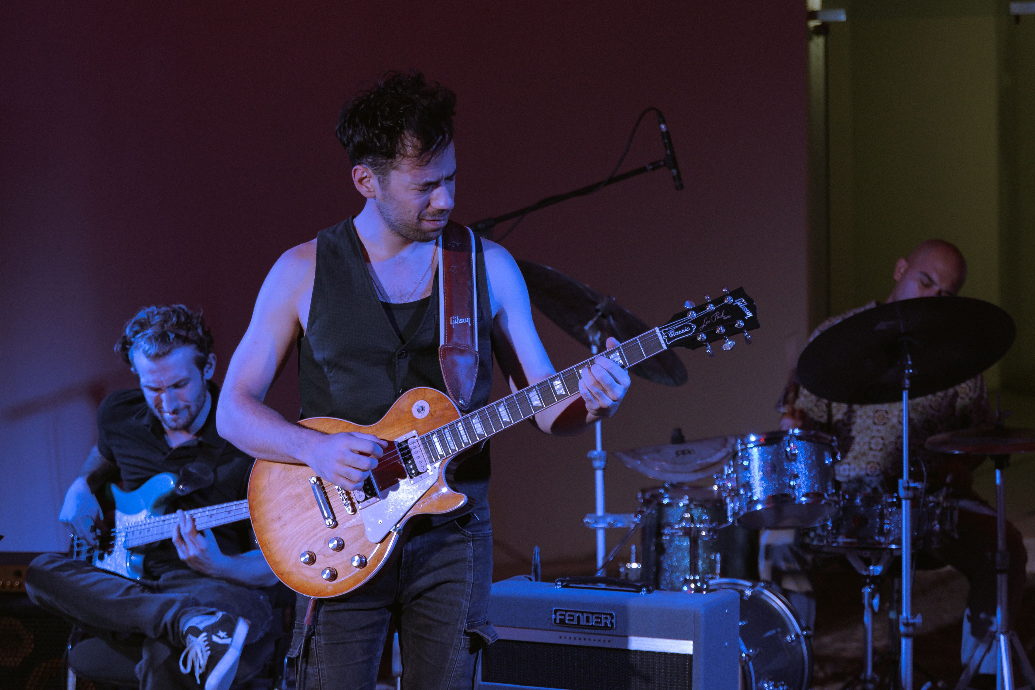 A man playing guitar in front of a band · Free Stock Photo