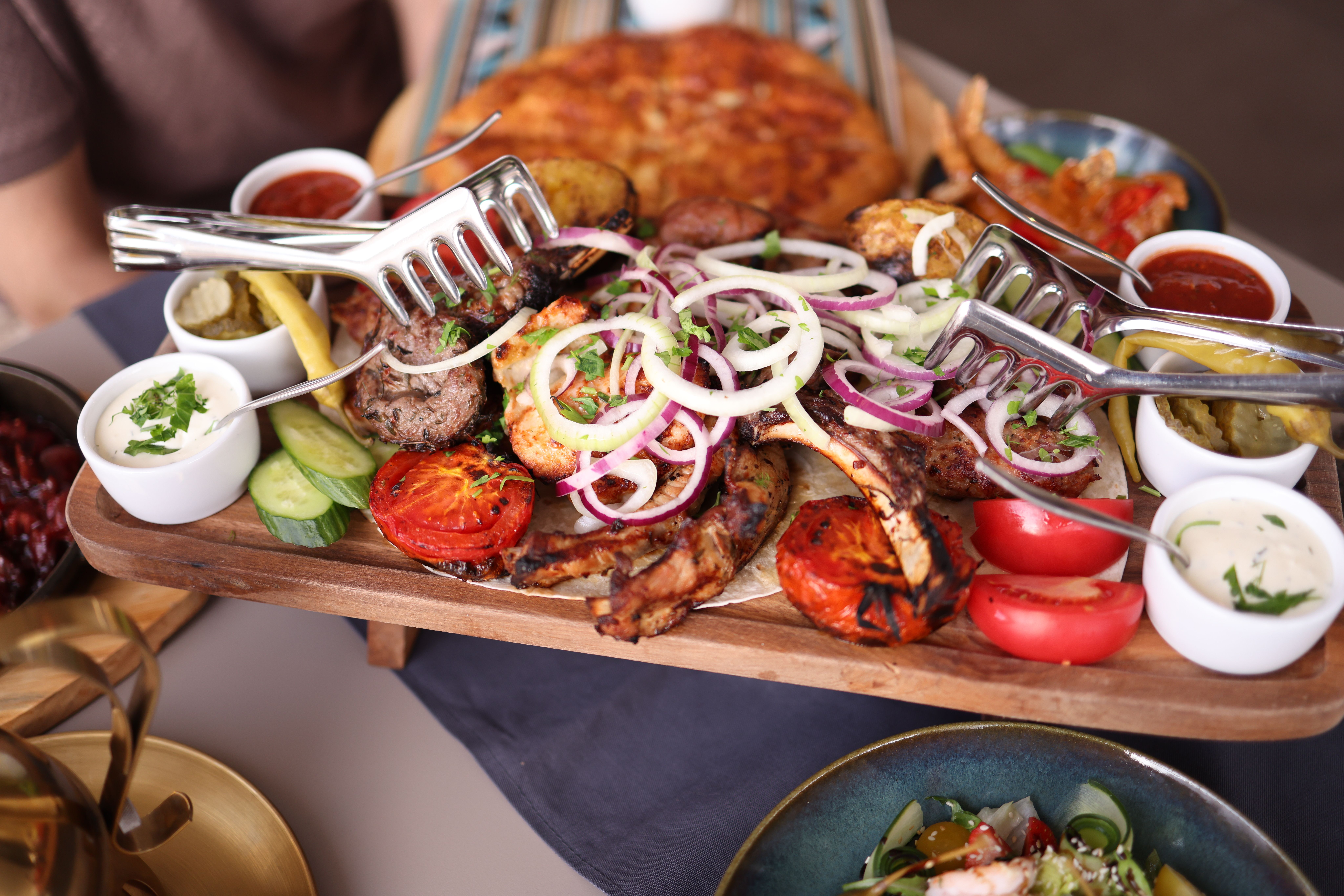 A large platter of food with various types of meat and vegetables ...