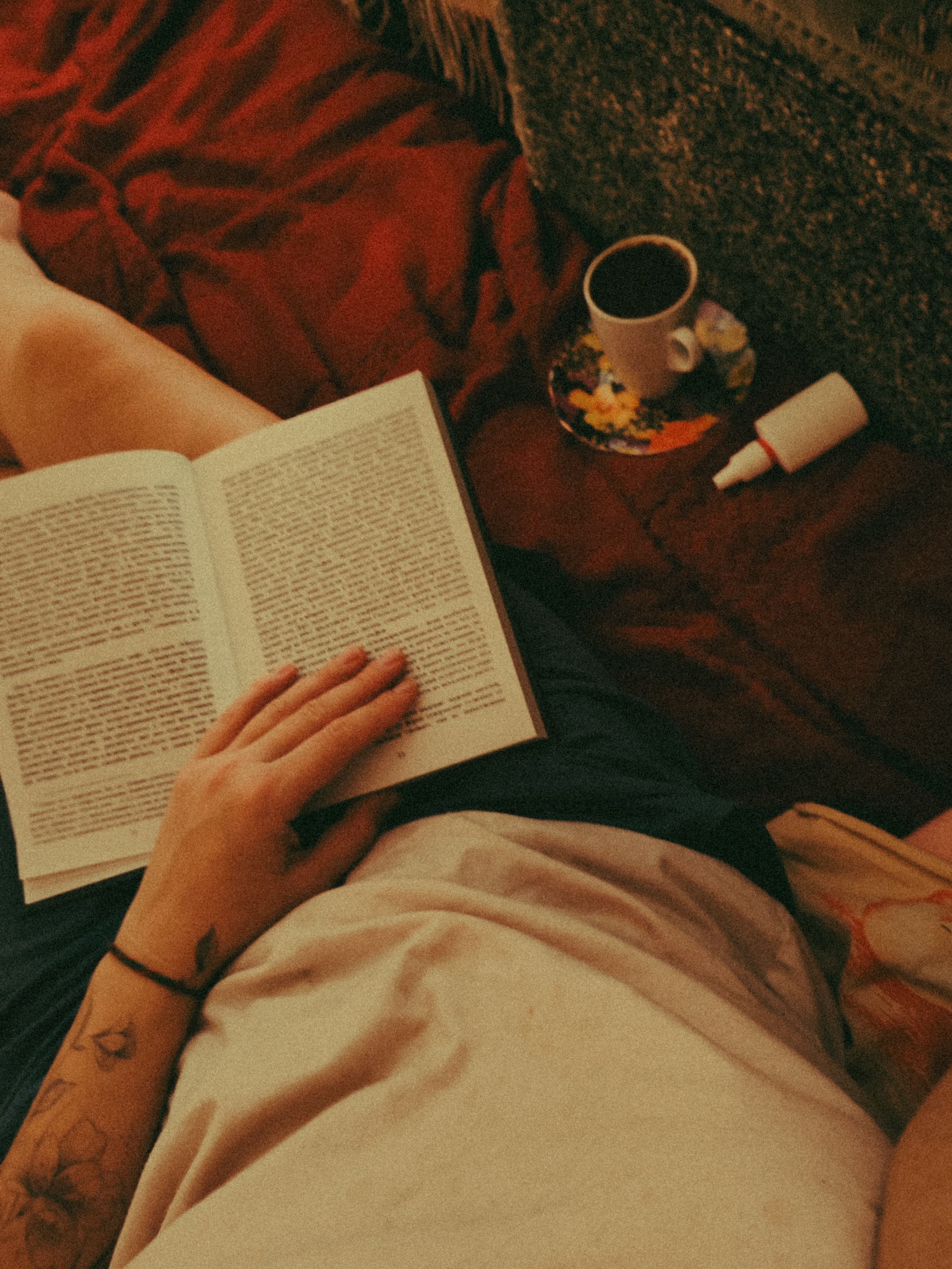 Young Woman Laying in Bed and Holding Book over Head · Free Stock Photo