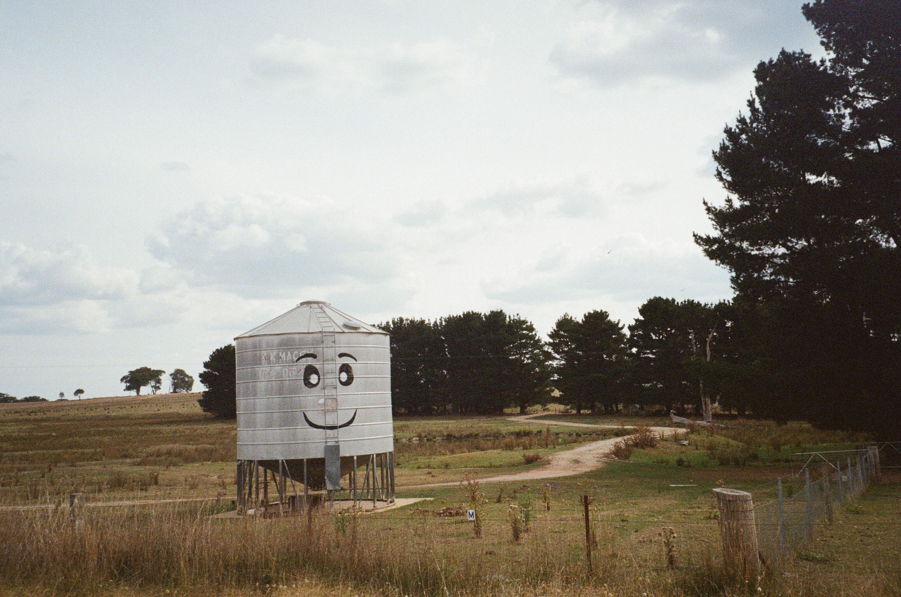 A large white water tower with a smiley face painted on it · Free Stock ...
