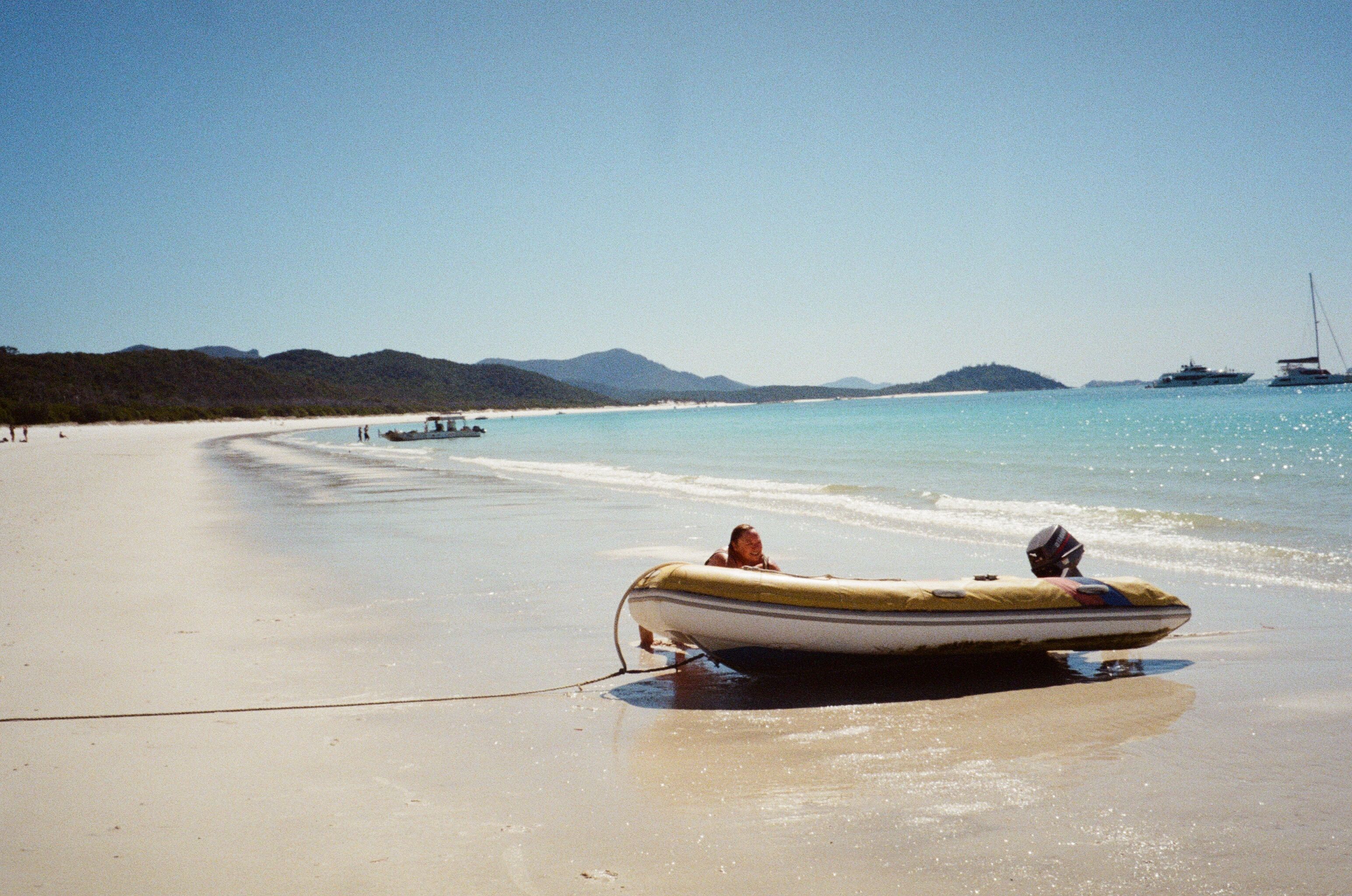 A boat on the beach with a person on it · Free Stock Photo