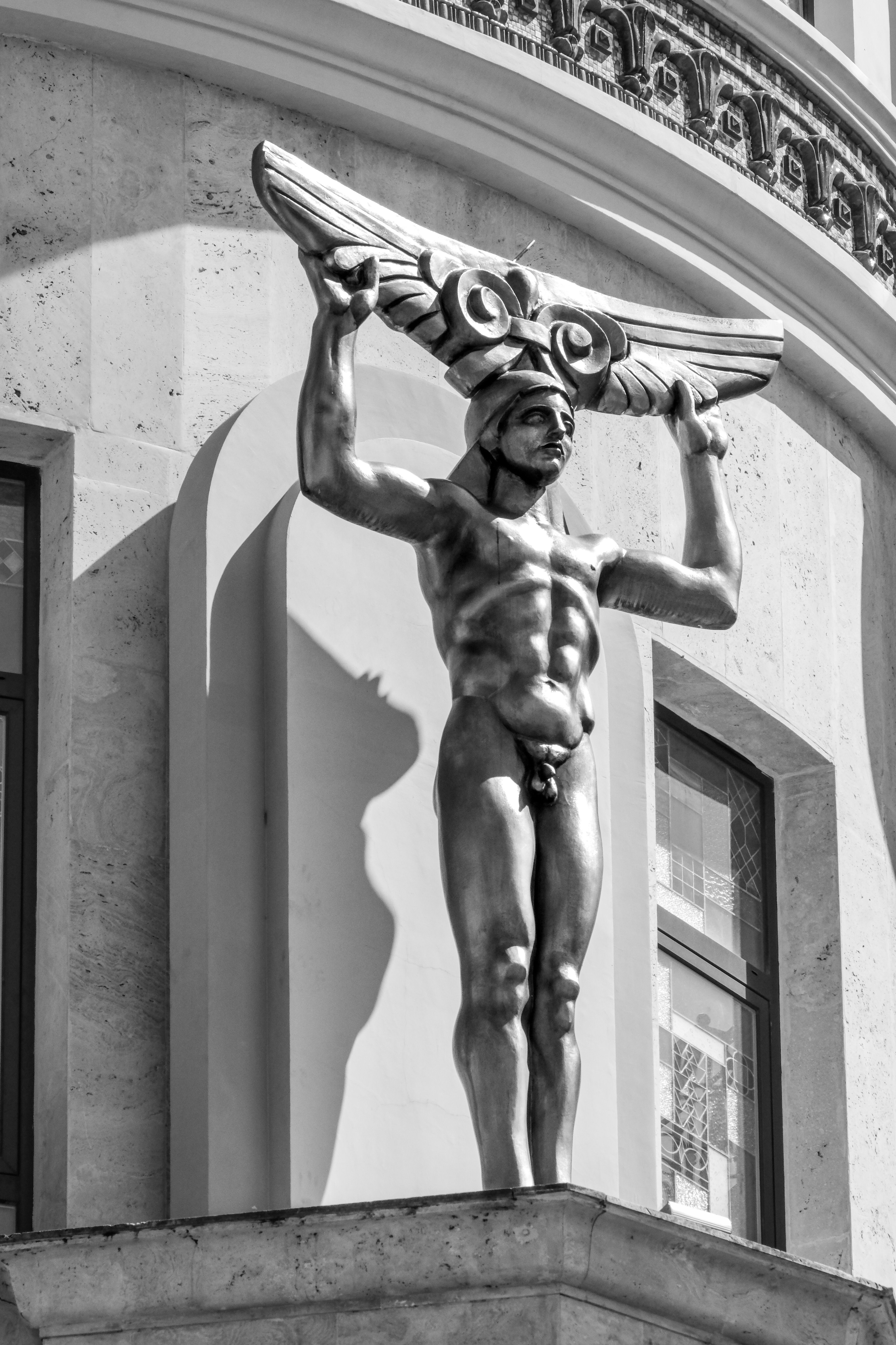 A statue of a man on top of a building · Free Stock Photo