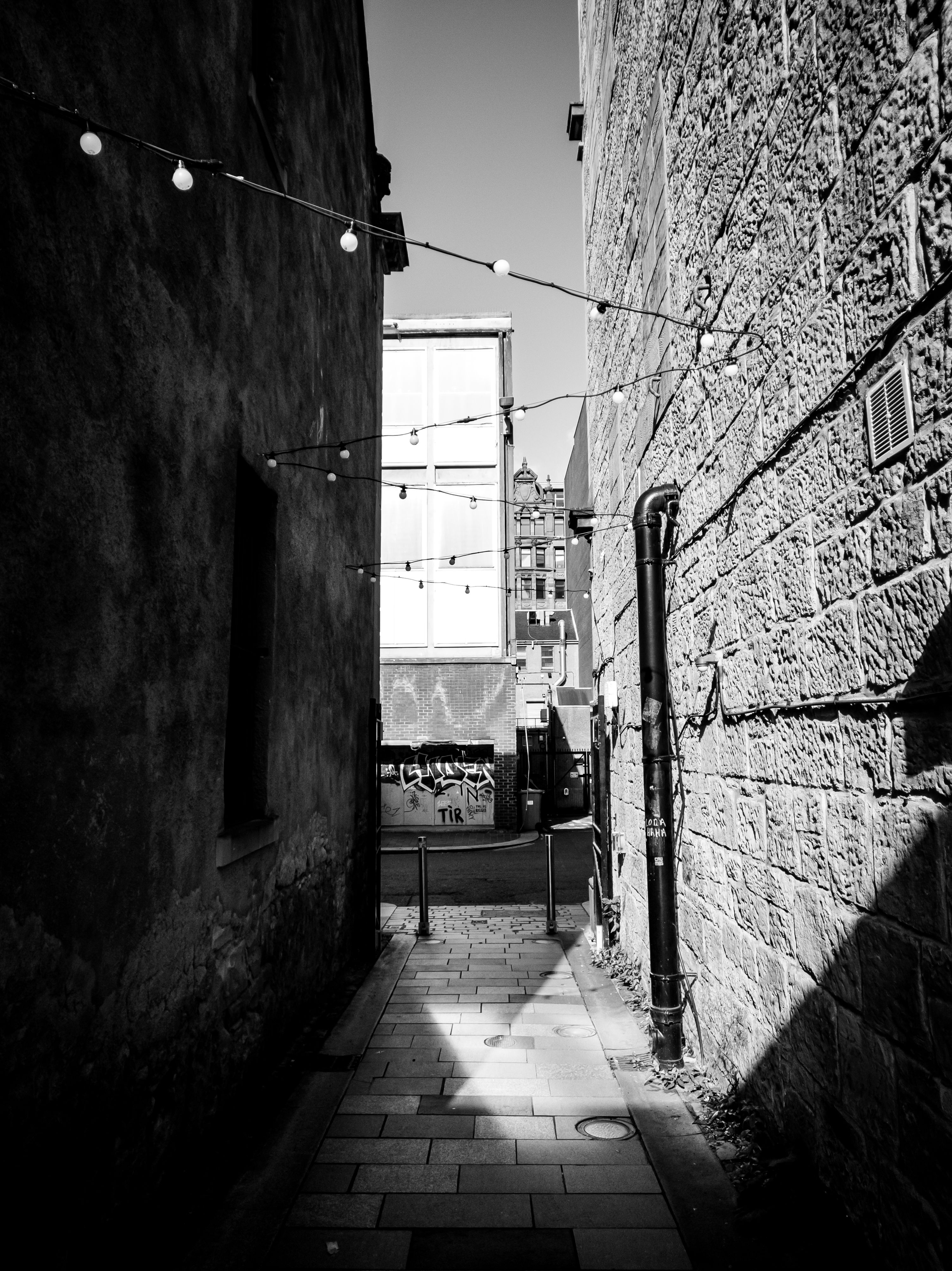A black and white photo of a narrow alley · Free Stock Photo