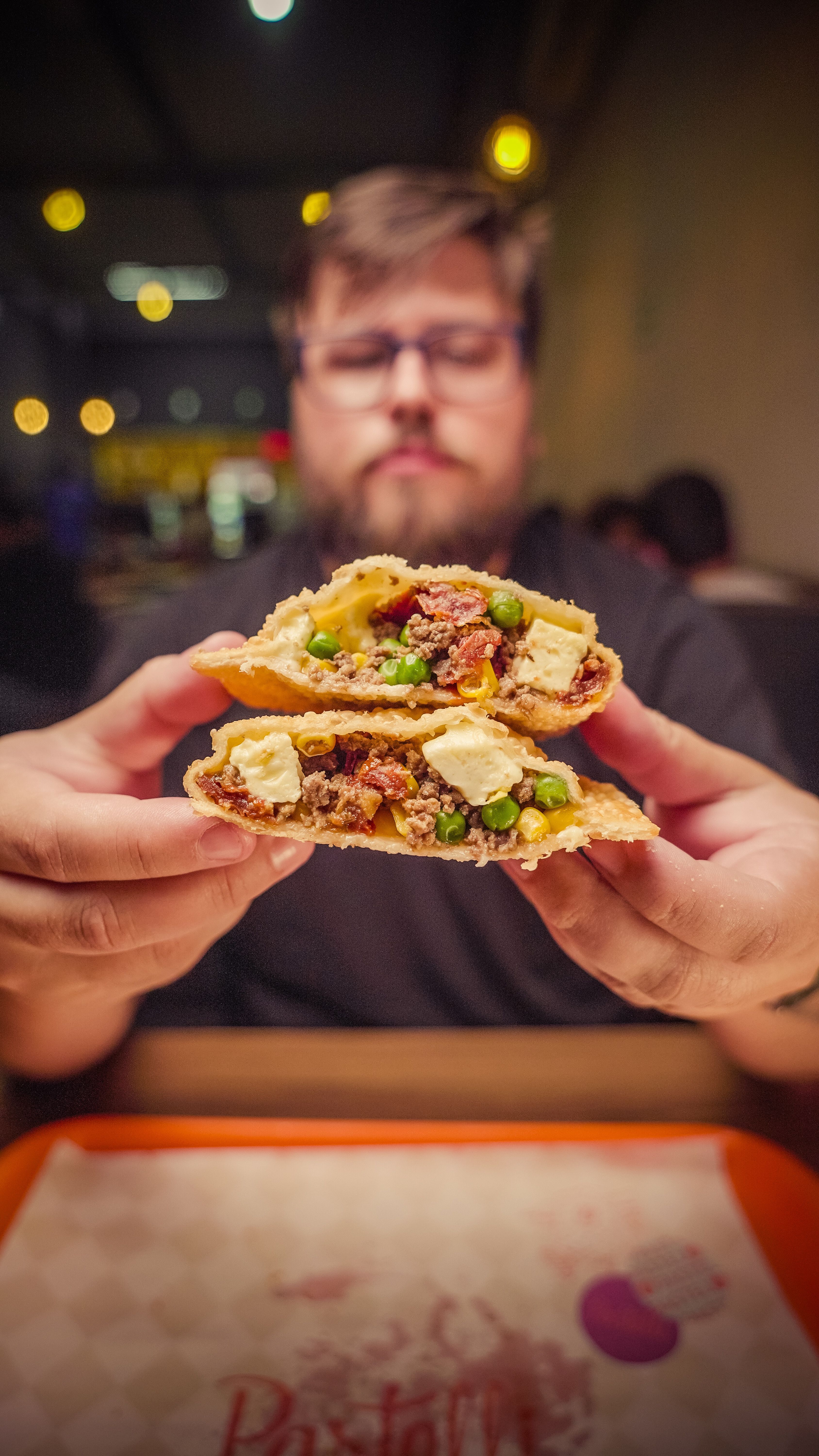 A man holding a sandwich in his hand · Free Stock Photo