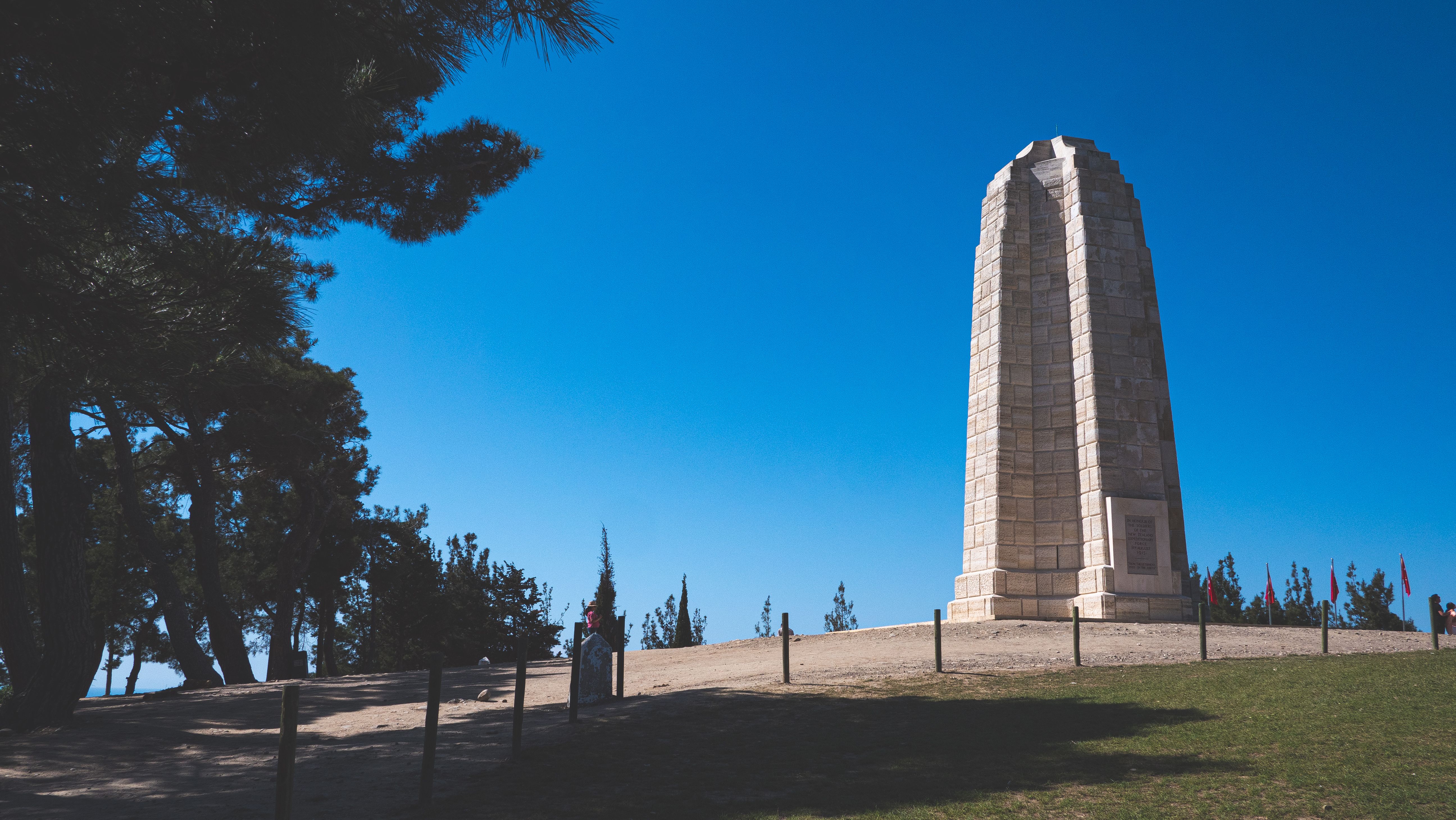 A monument with a blue sky and trees · Free Stock Photo