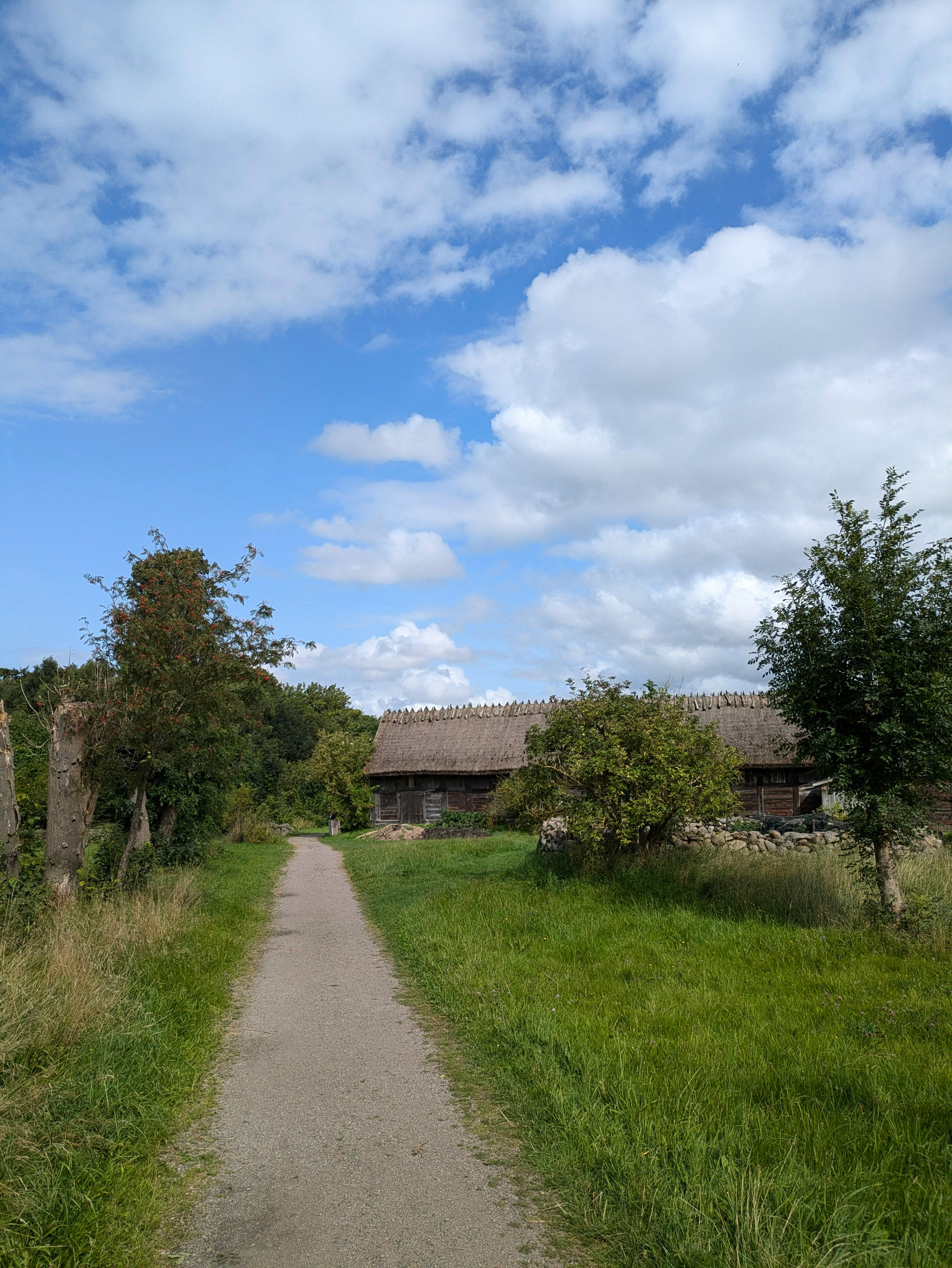 A path leading to a thatched cottage · Free Stock Photo
