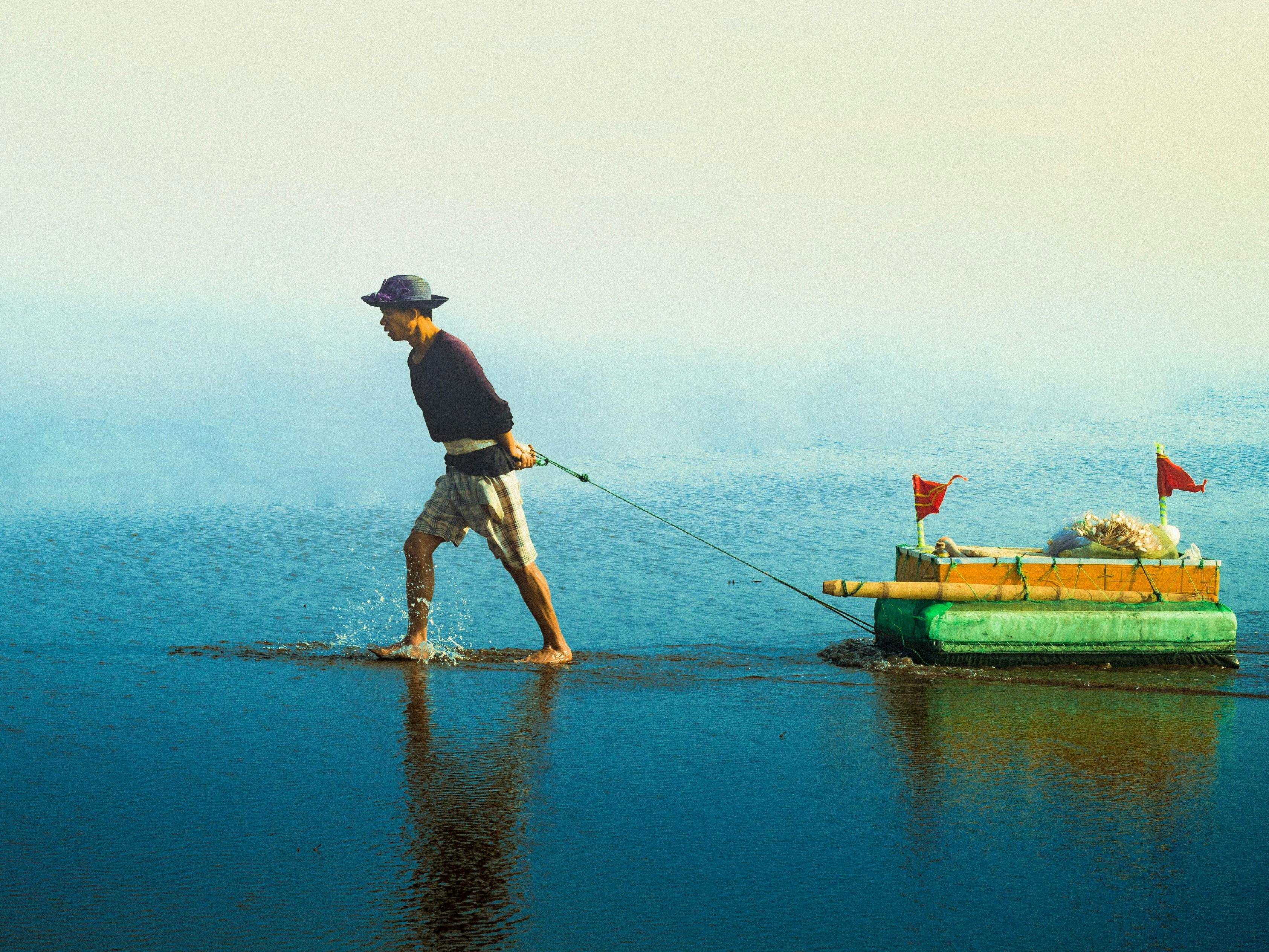 Man Holding a Stick with Perched Bird · Free Stock Photo