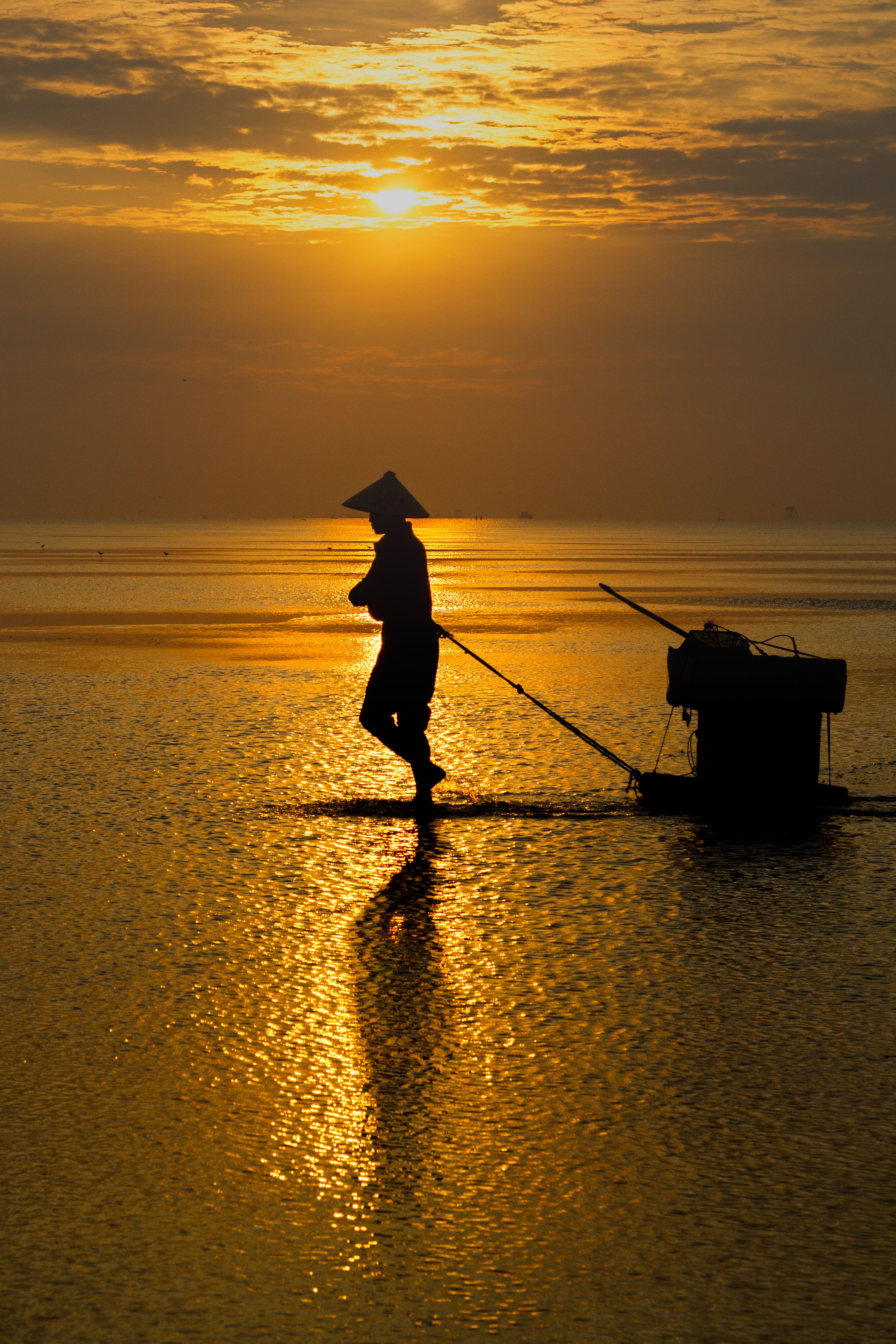 A man walking on the water with a fishing net · Free Stock Photo
