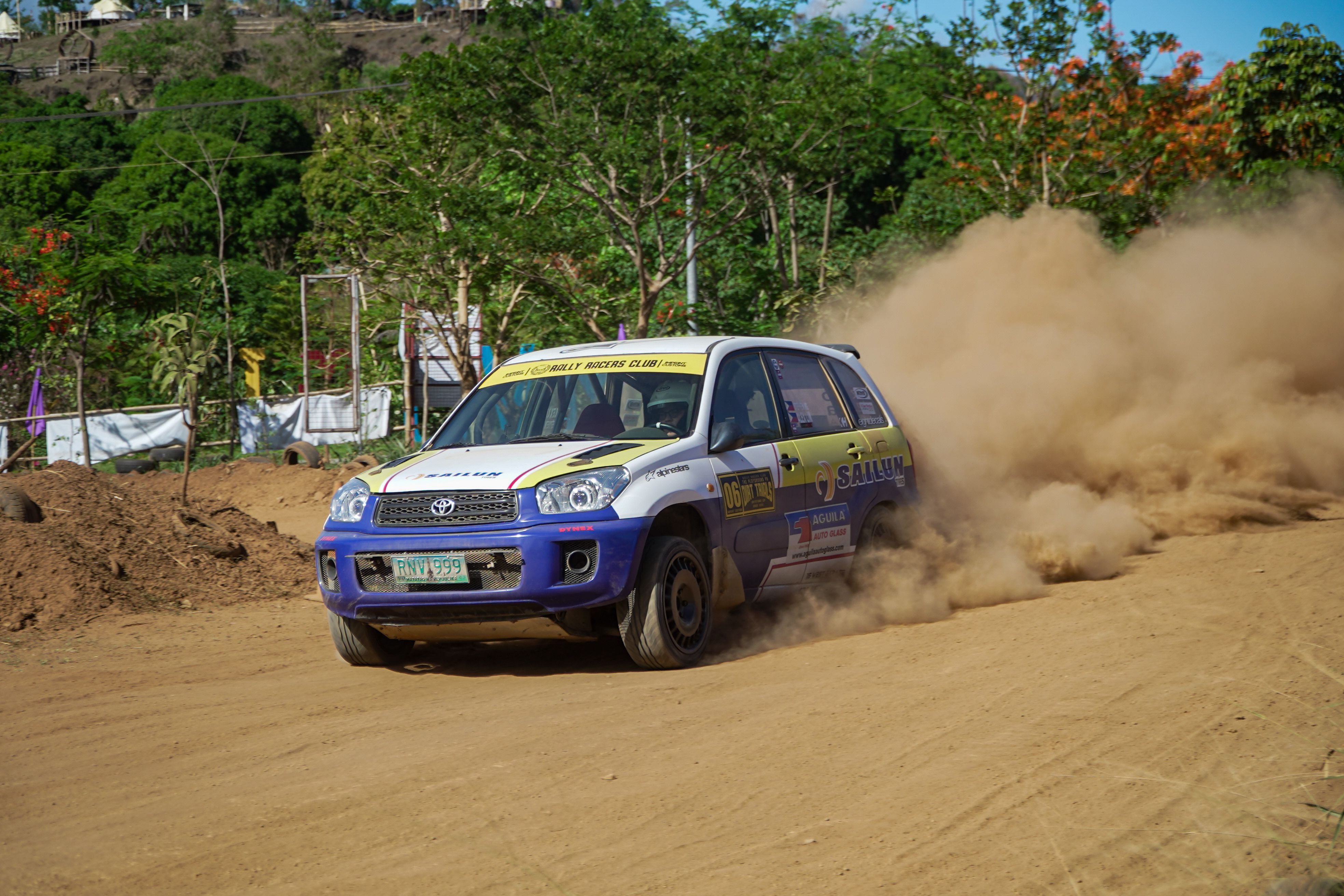 A car driving on dirt road with dust flying up · Free Stock Photo