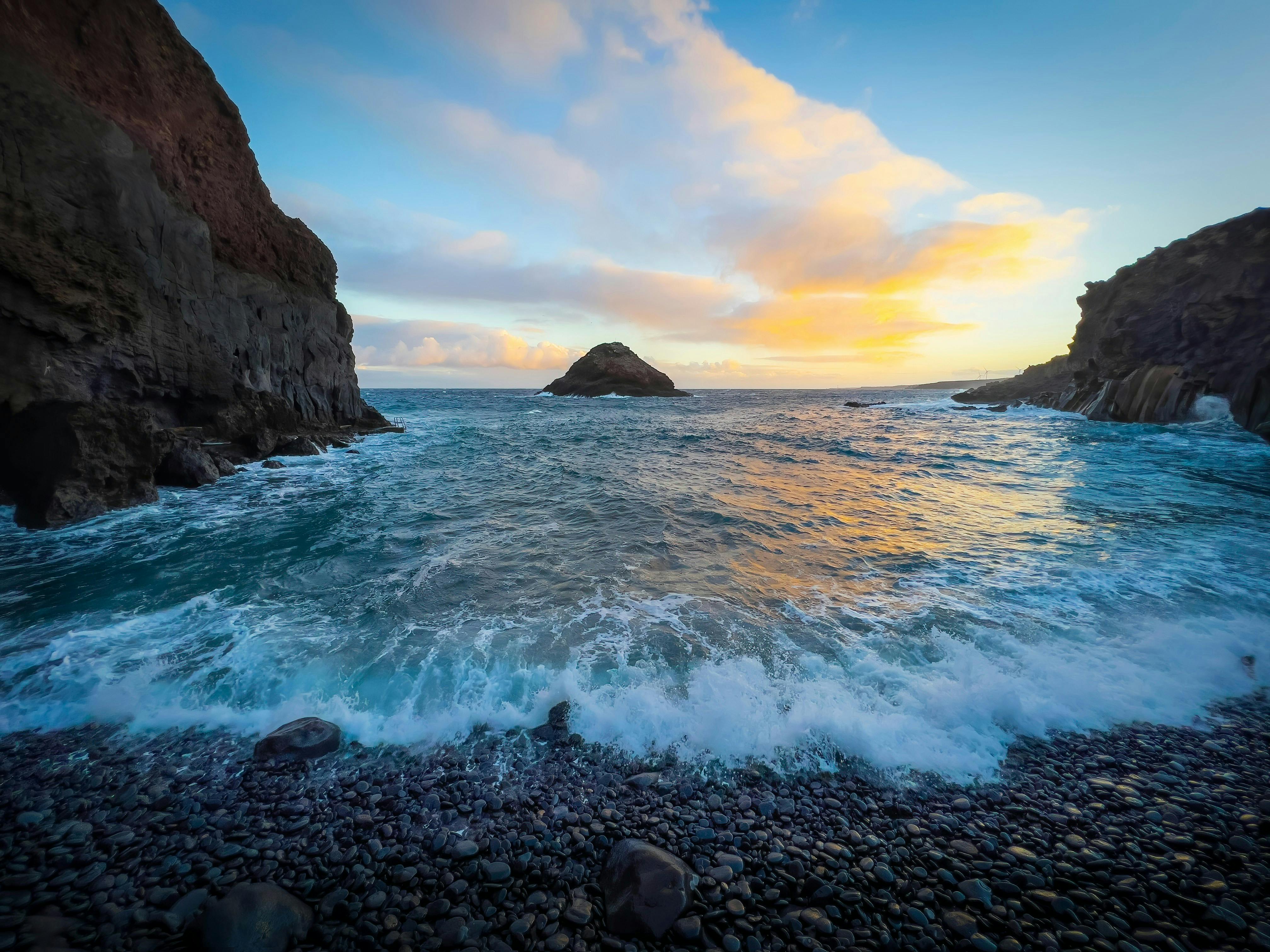 Brown and Gray Rocks on Seashore during Sunset · Free Stock Photo