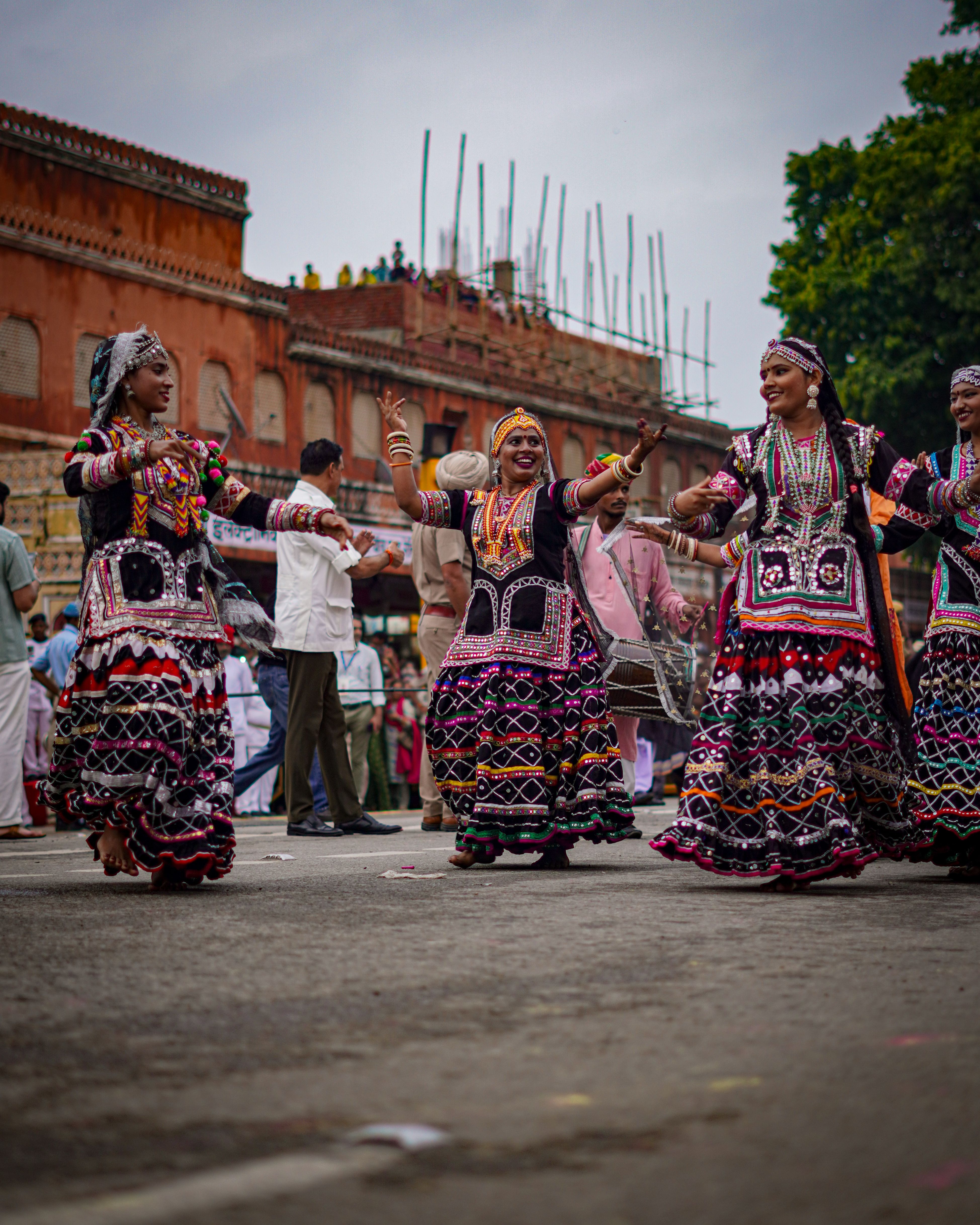 Women in traditional indian clothing dance on the street · Free Stock Photo