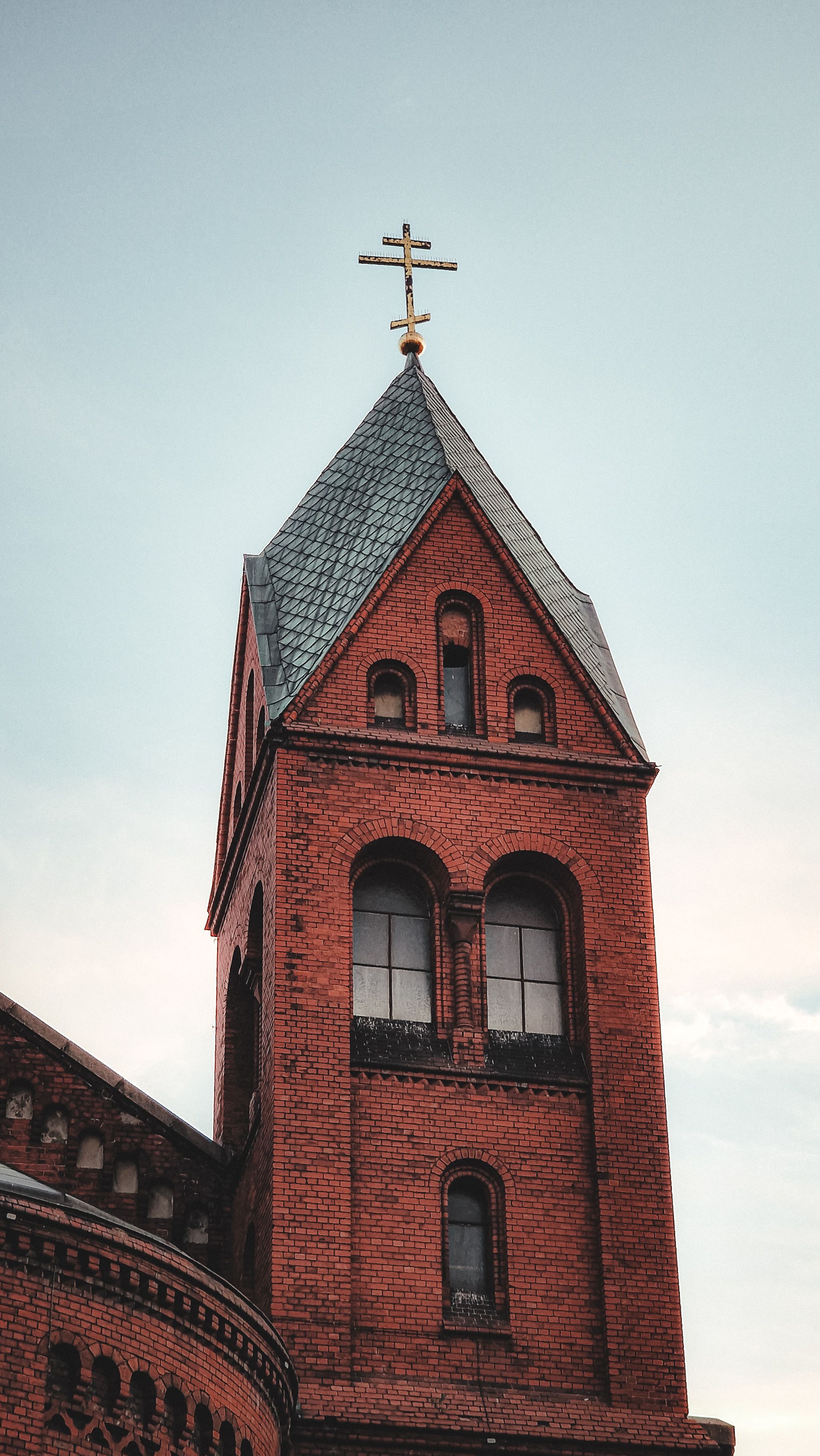 A church tower with a cross on top · Free Stock Photo