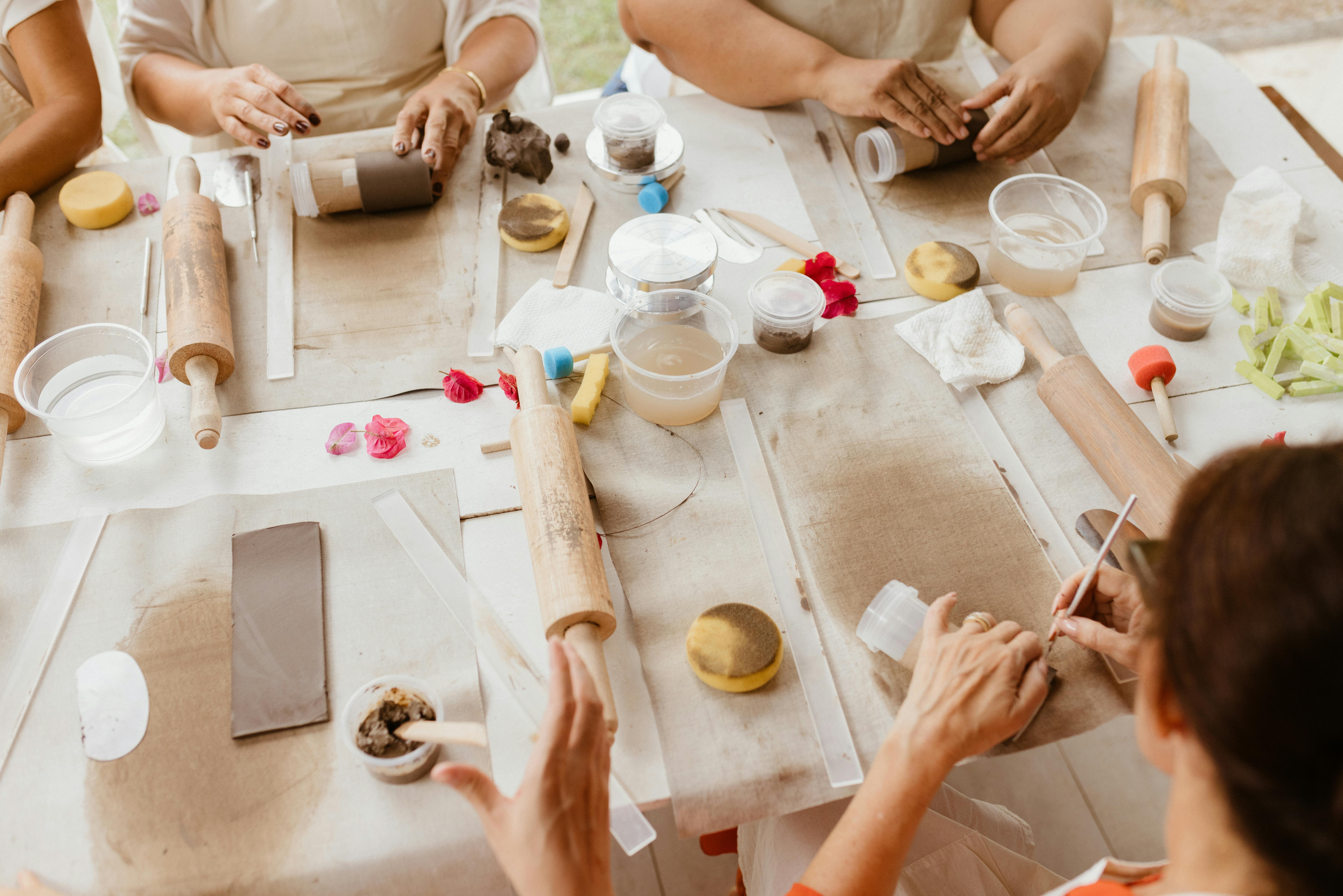 A group of people making crafts at a table · Free Stock Photo