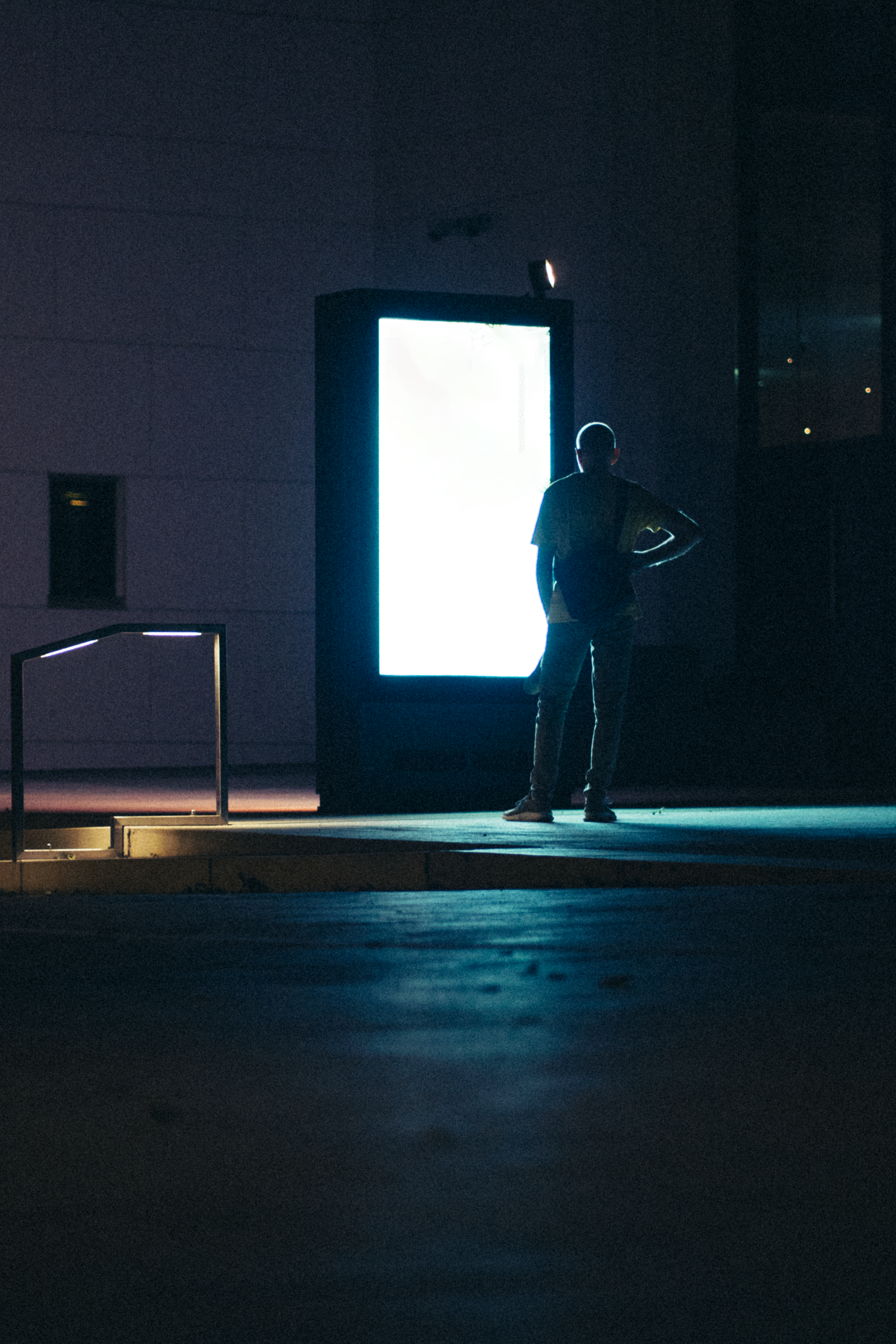 A man standing in front of a large screen · Free Stock Photo