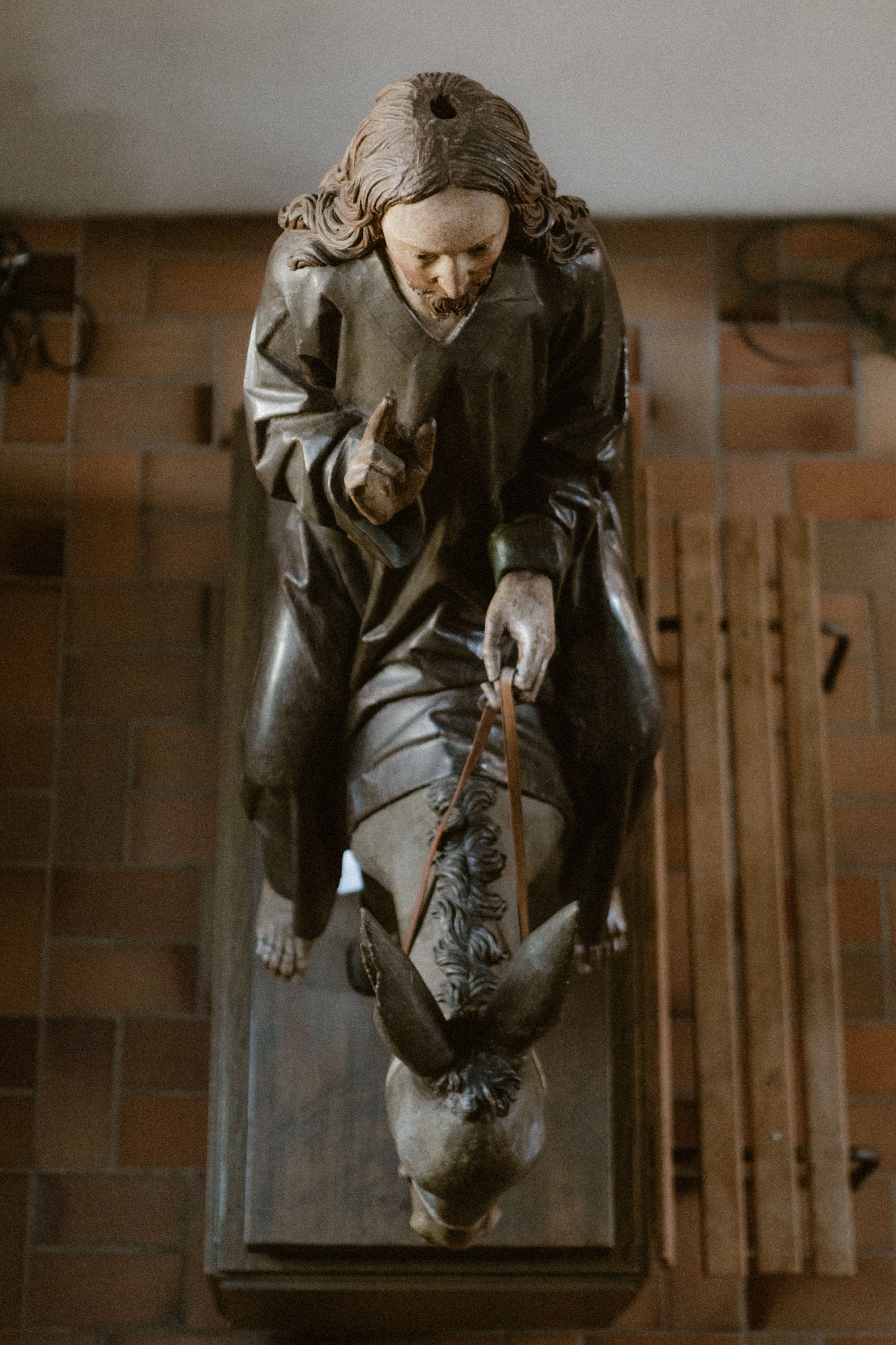 A statue of jesus riding a donkey in a church · Free Stock Photo