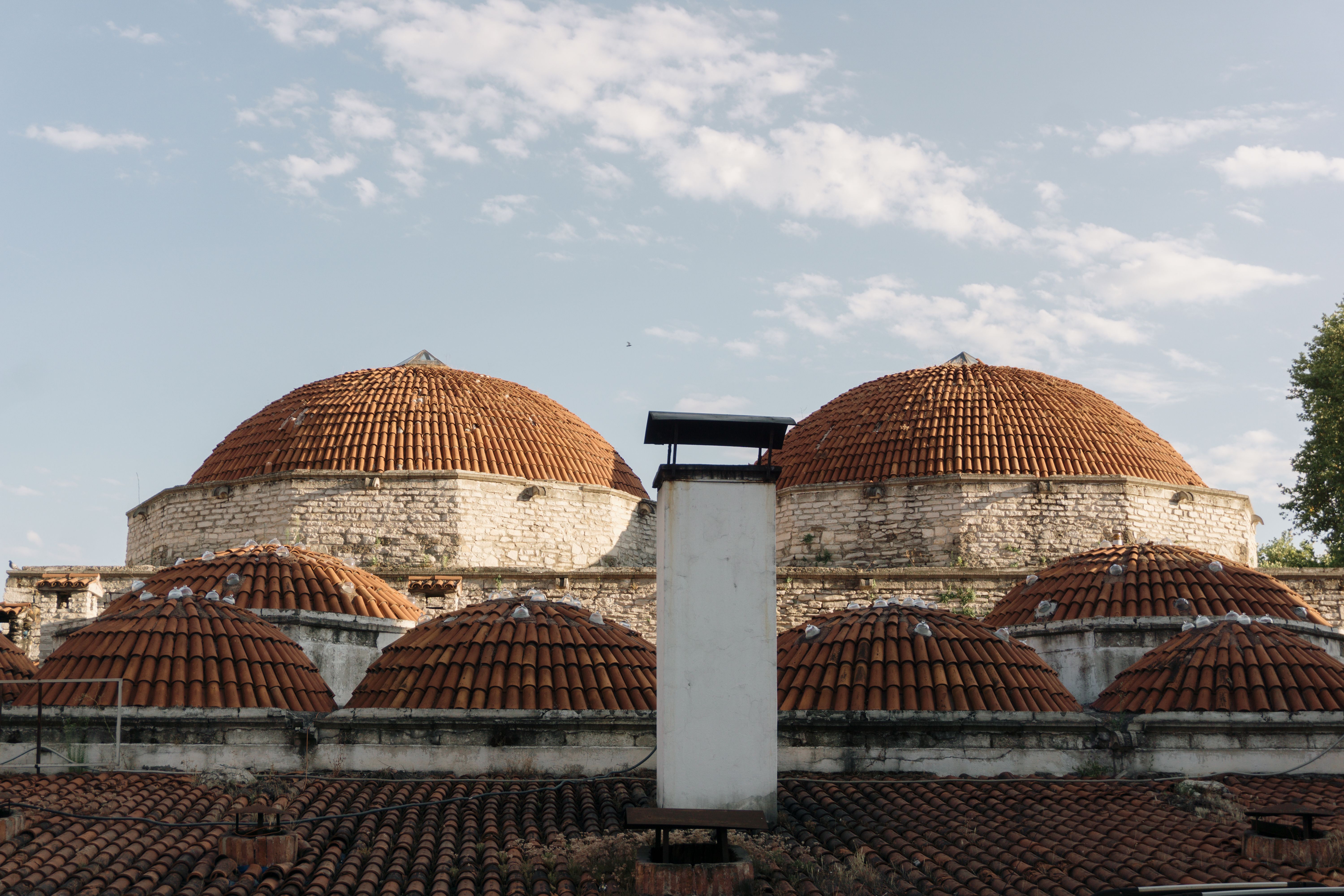 The domes of a mosque on top of a roof · Free Stock Photo