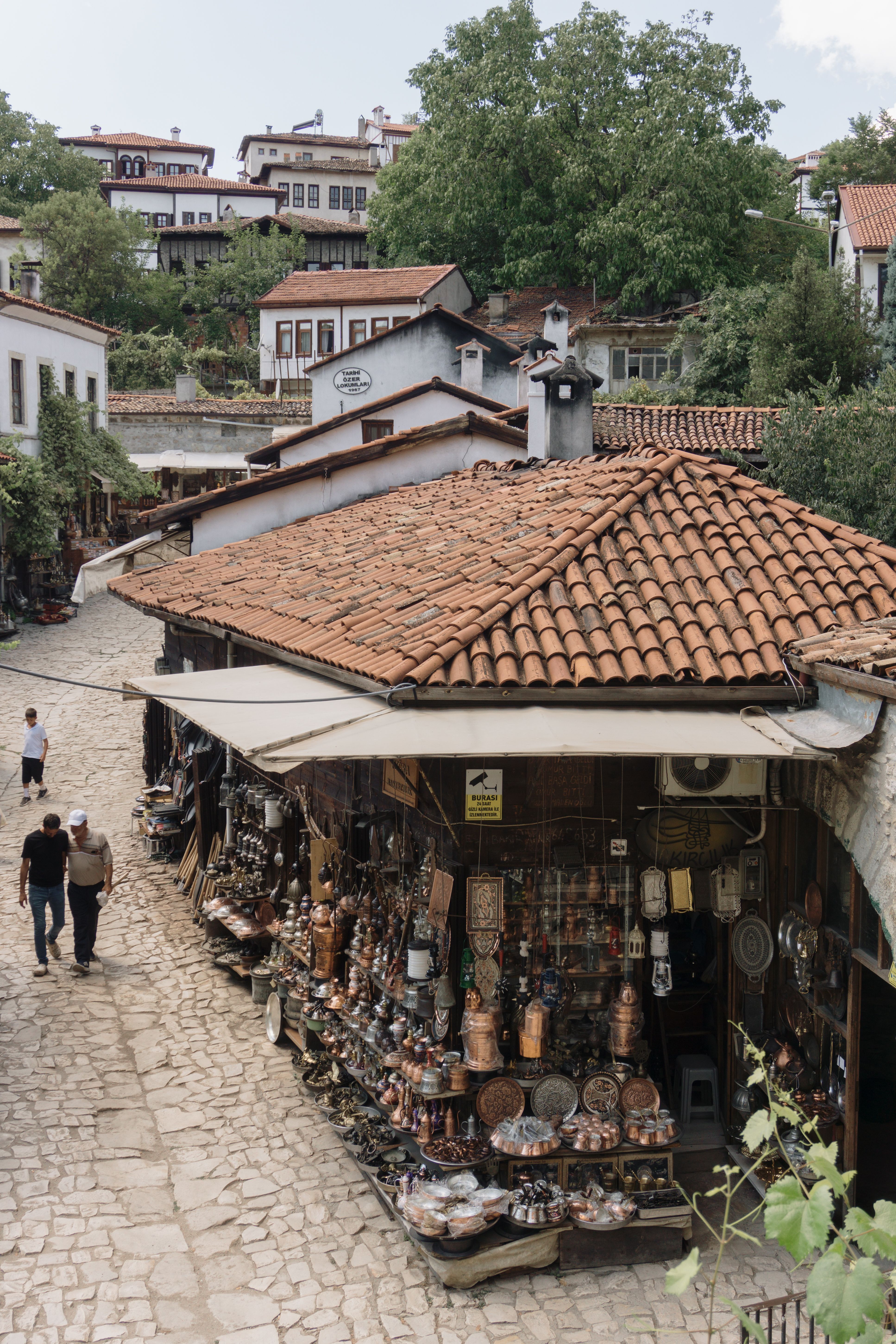A street with shops and people walking around · Free Stock Photo
