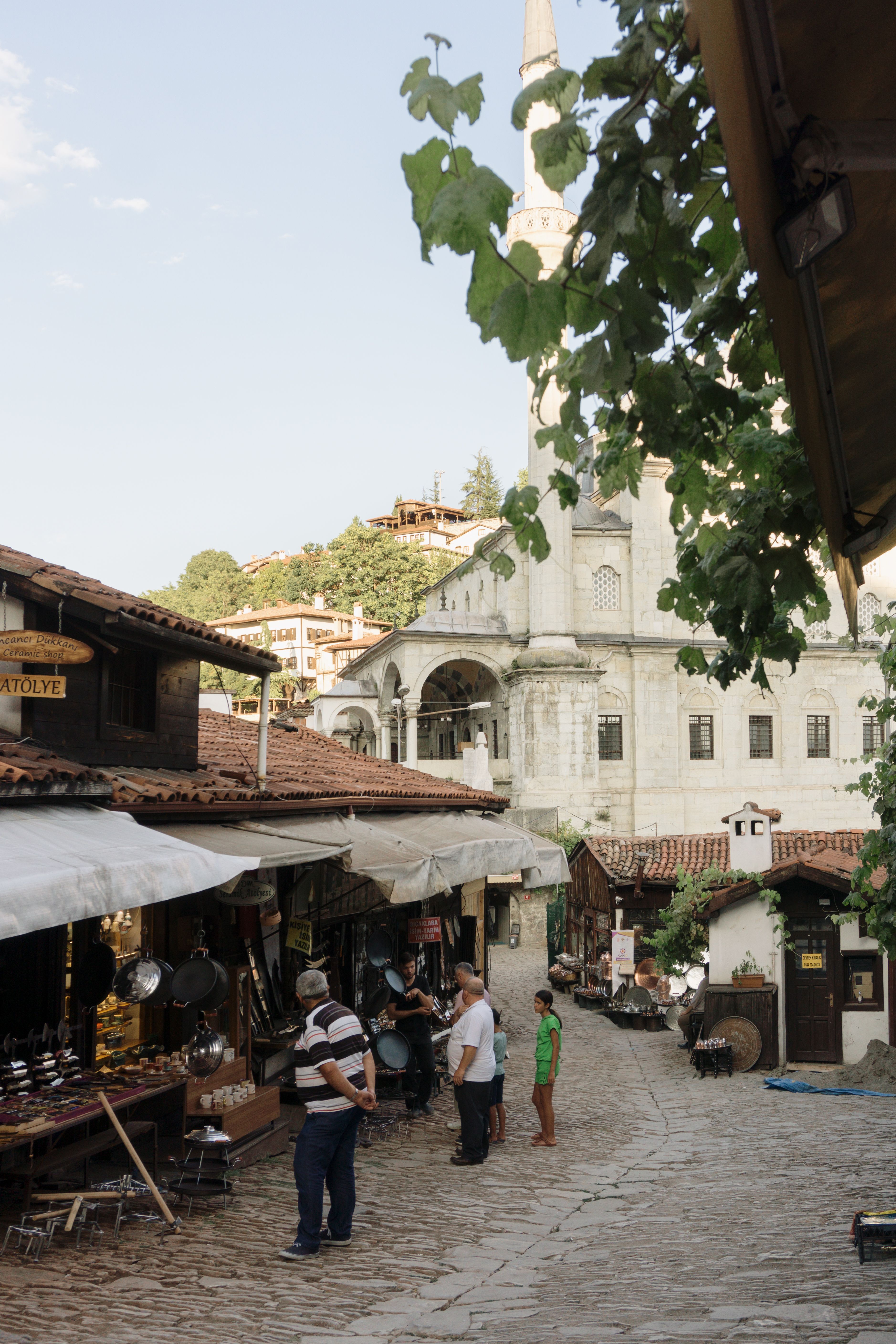 A street with people walking around and shops · Free Stock Photo