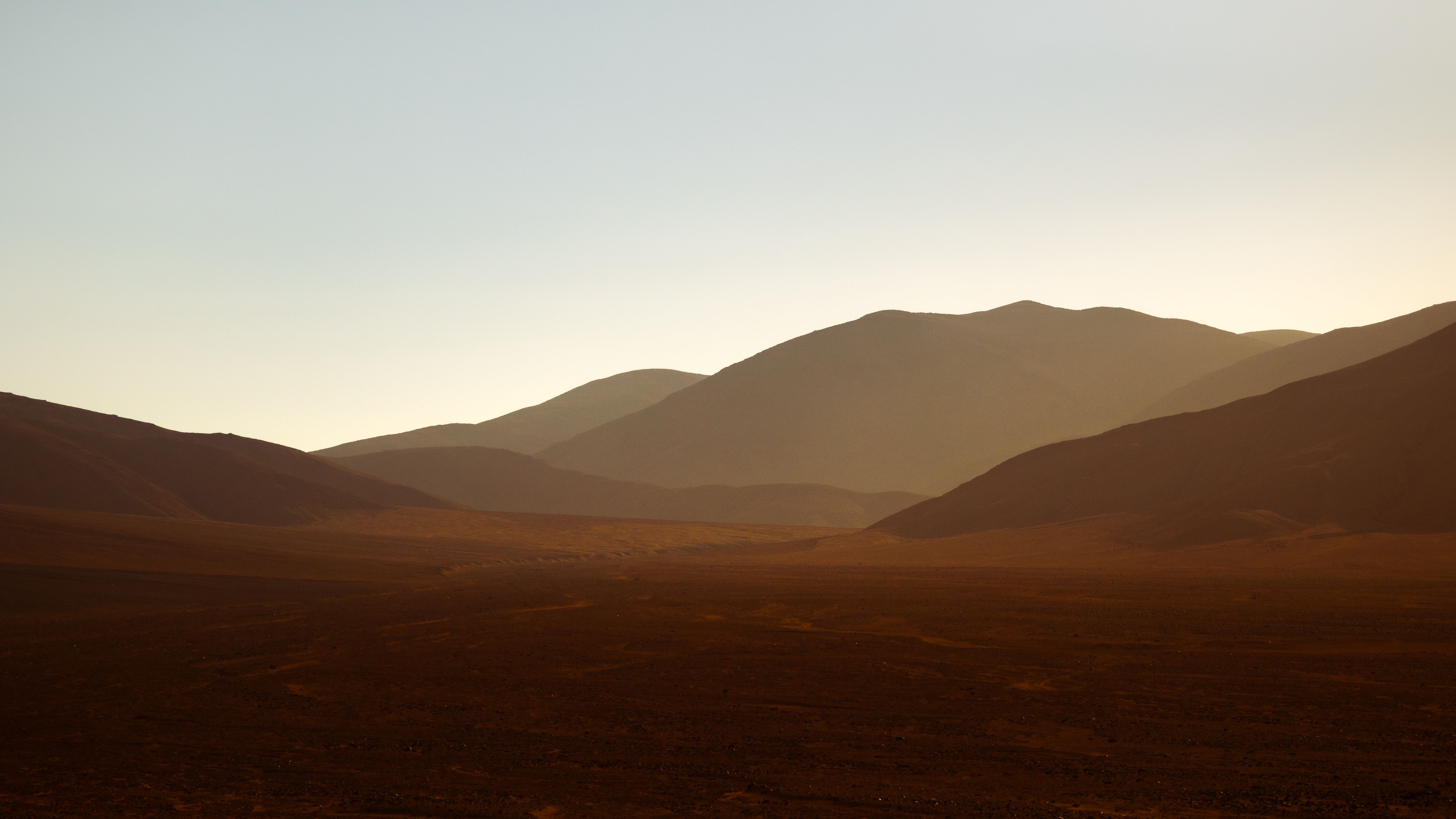 A desert landscape with mountains in the distance · Free Stock Photo