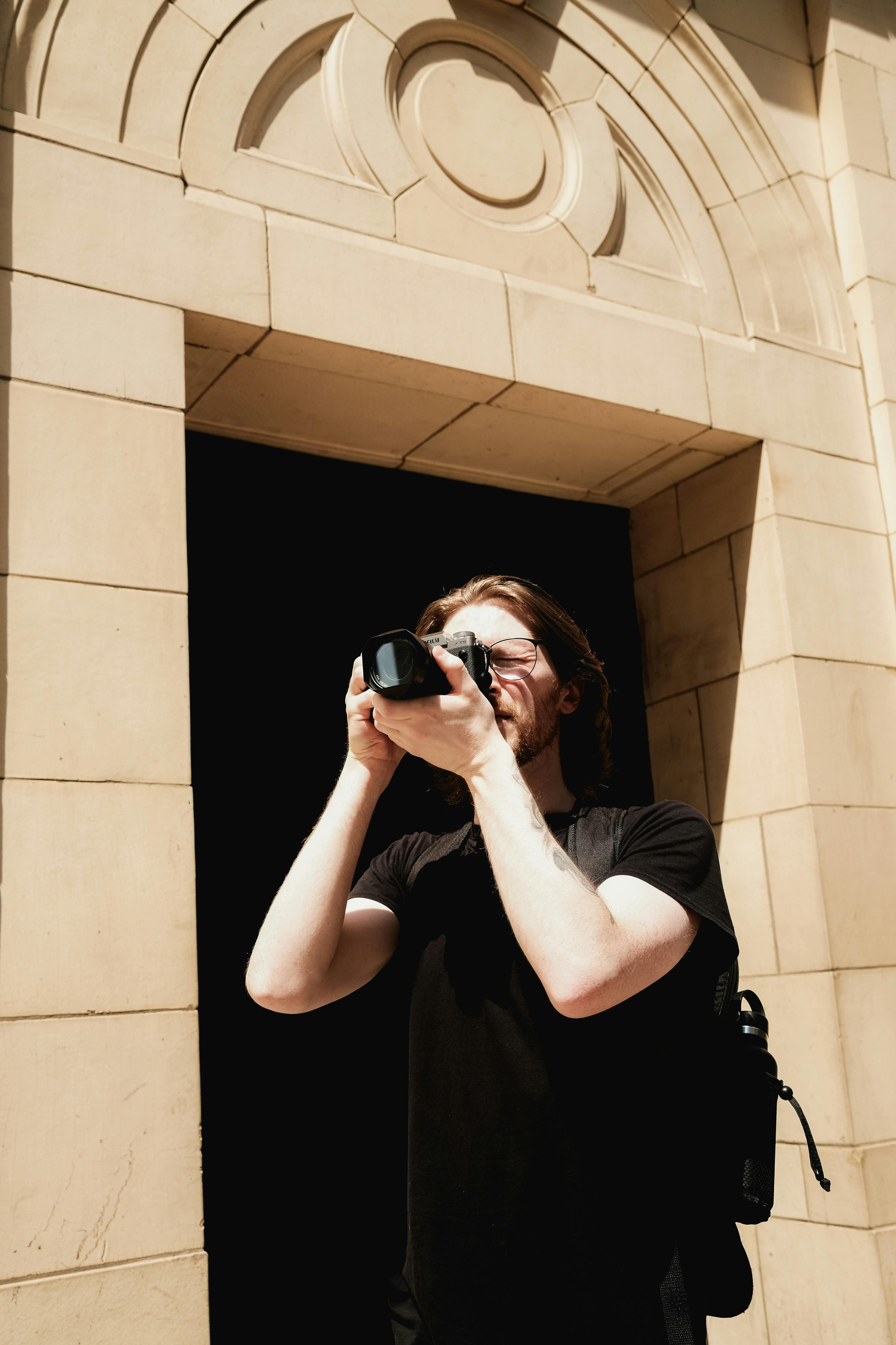 A man taking a picture of a building · Free Stock Photo
