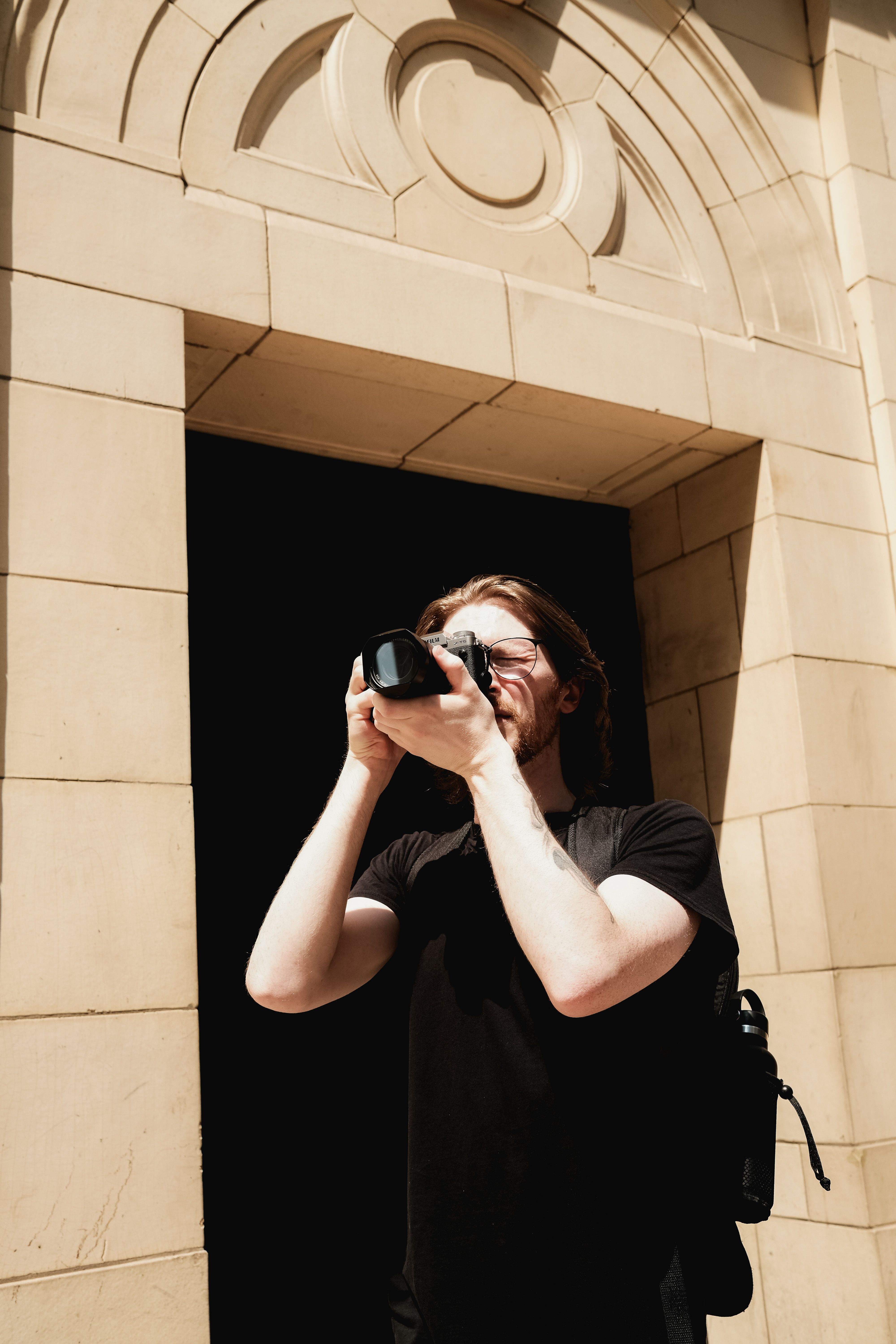 A man taking a picture of a building · Free Stock Photo