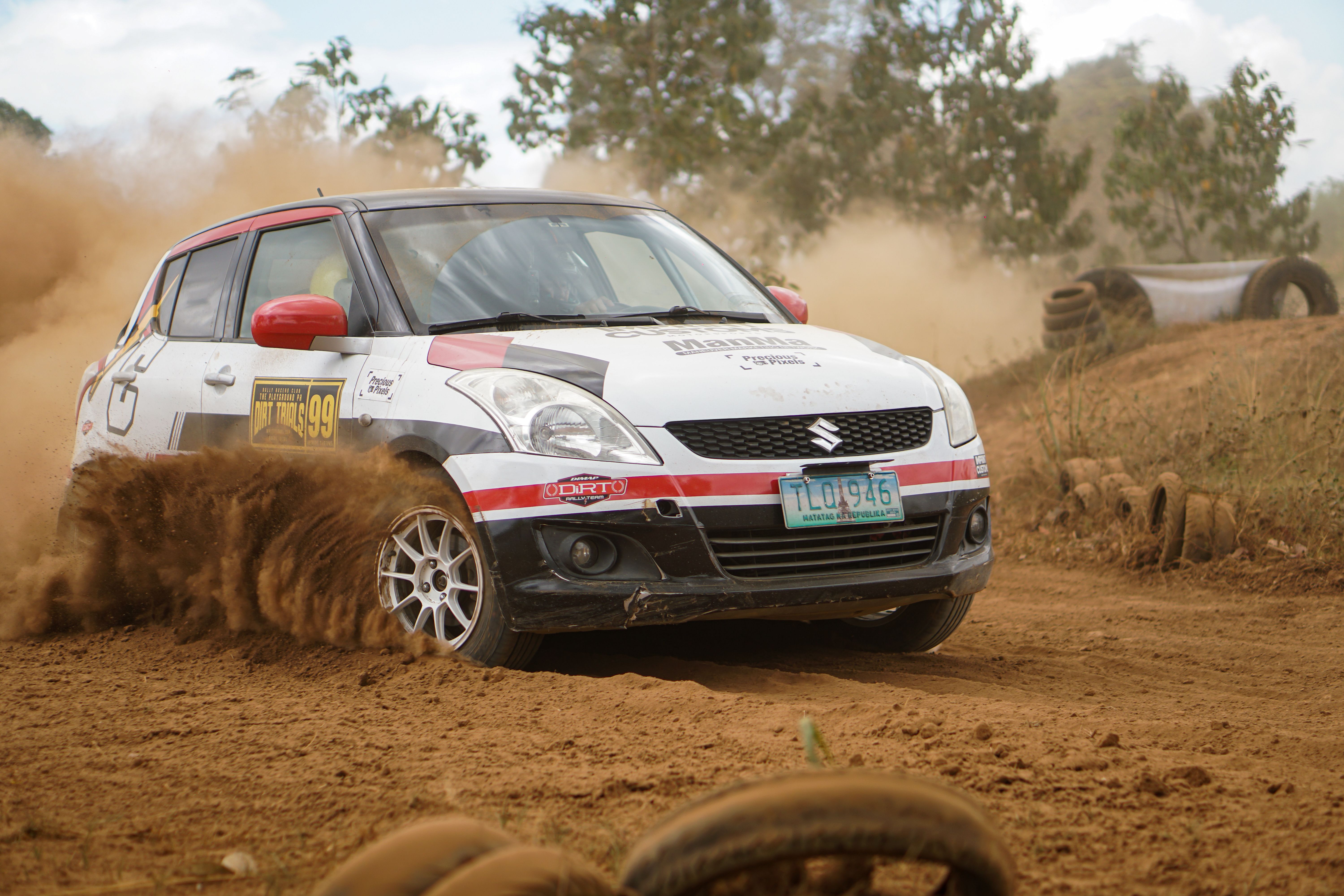 A car driving on dirt in the middle of a field · Free Stock Photo