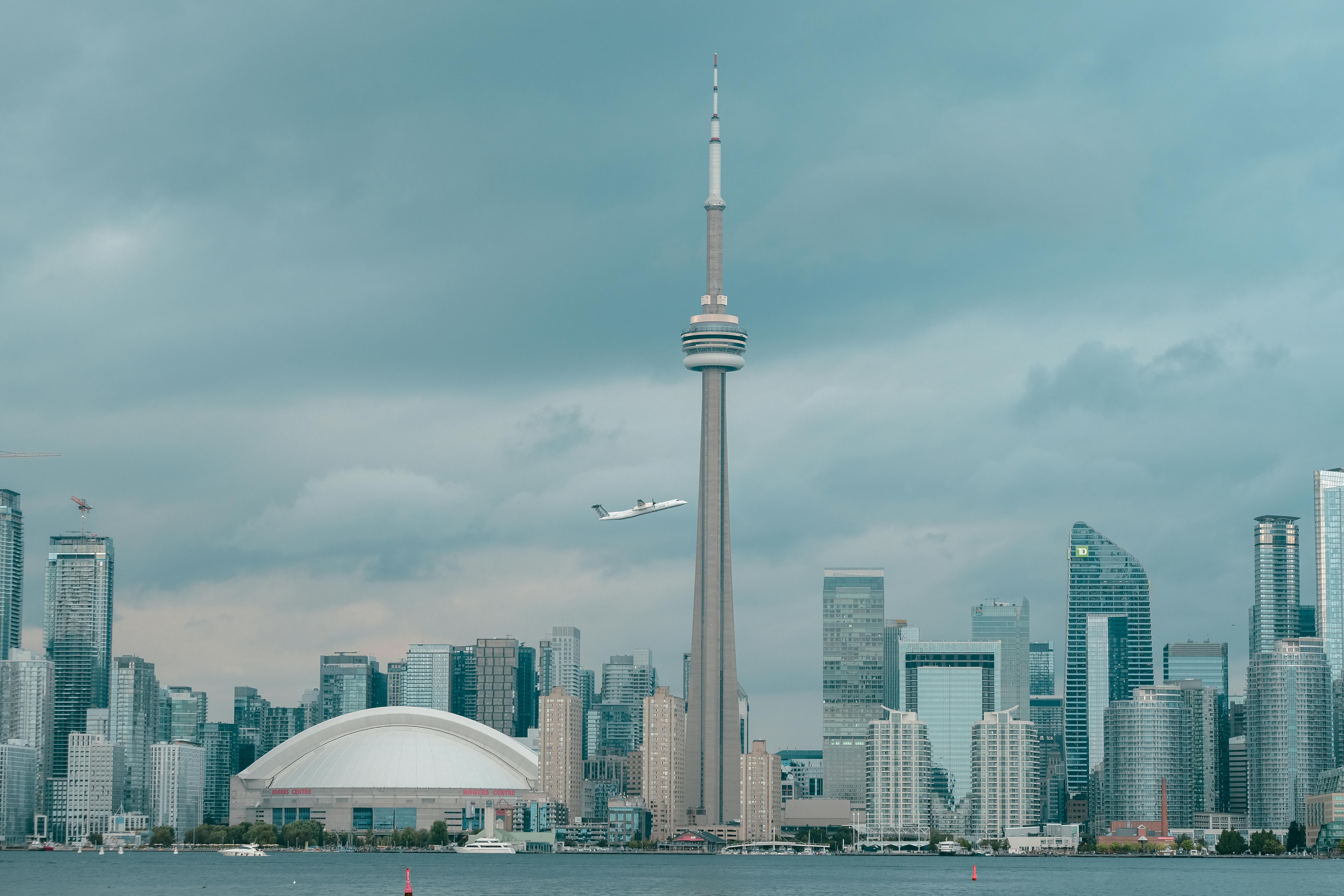 Private Jet Flying Over the CN Tower · Free Stock Photo