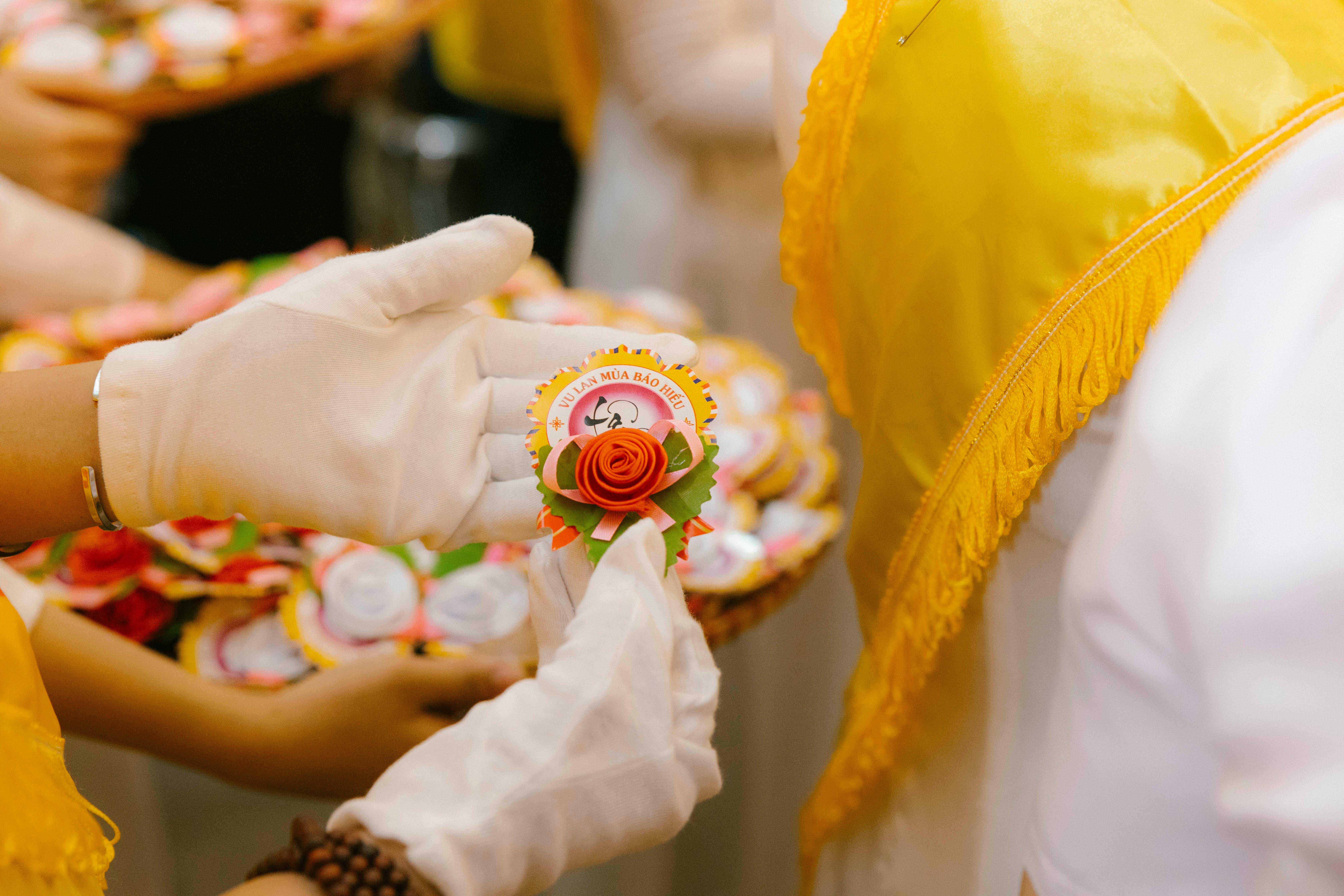 A person in white gloves holding a flower · Free Stock Photo