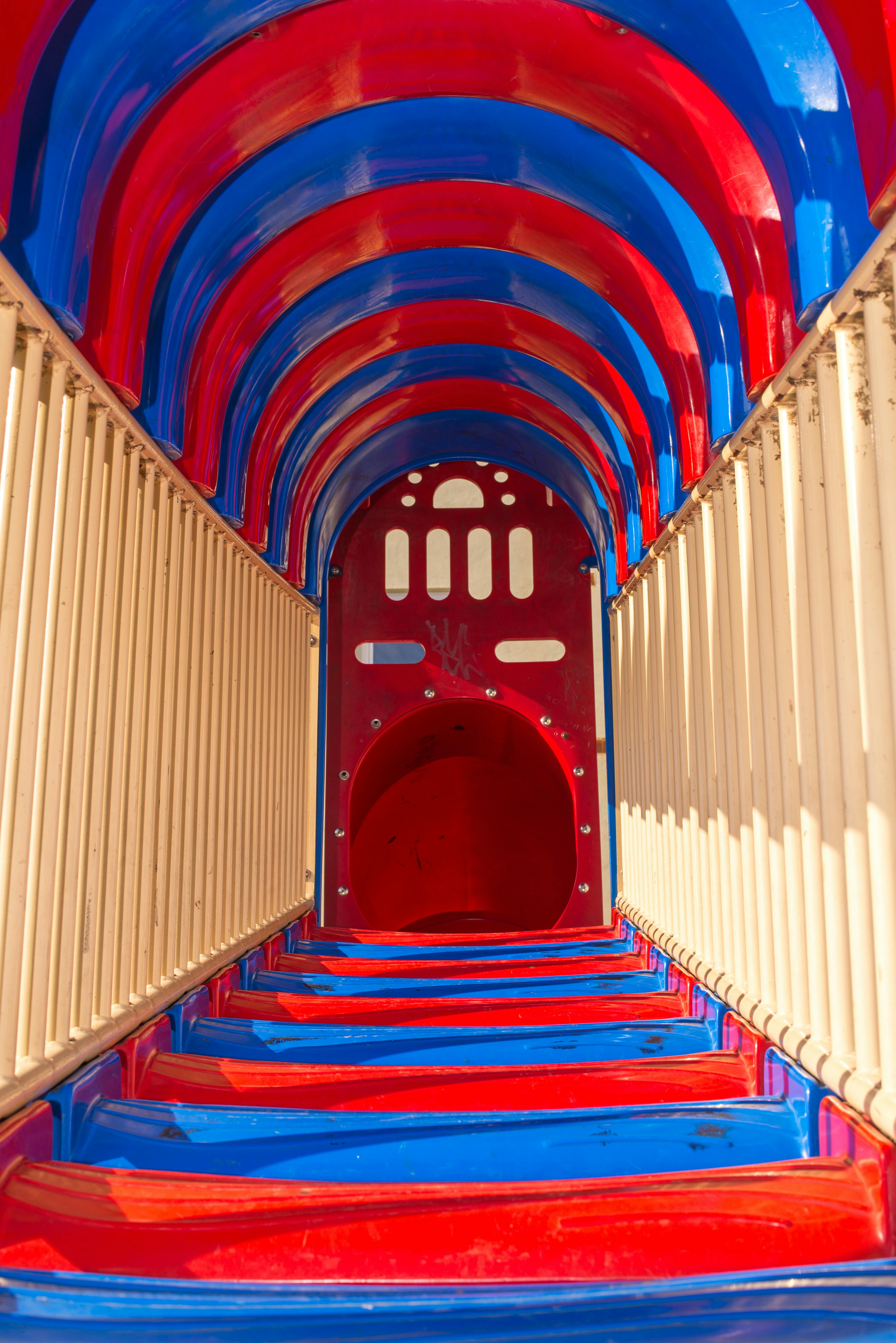 A red and blue slide with a red and blue tunnel · Free Stock Photo