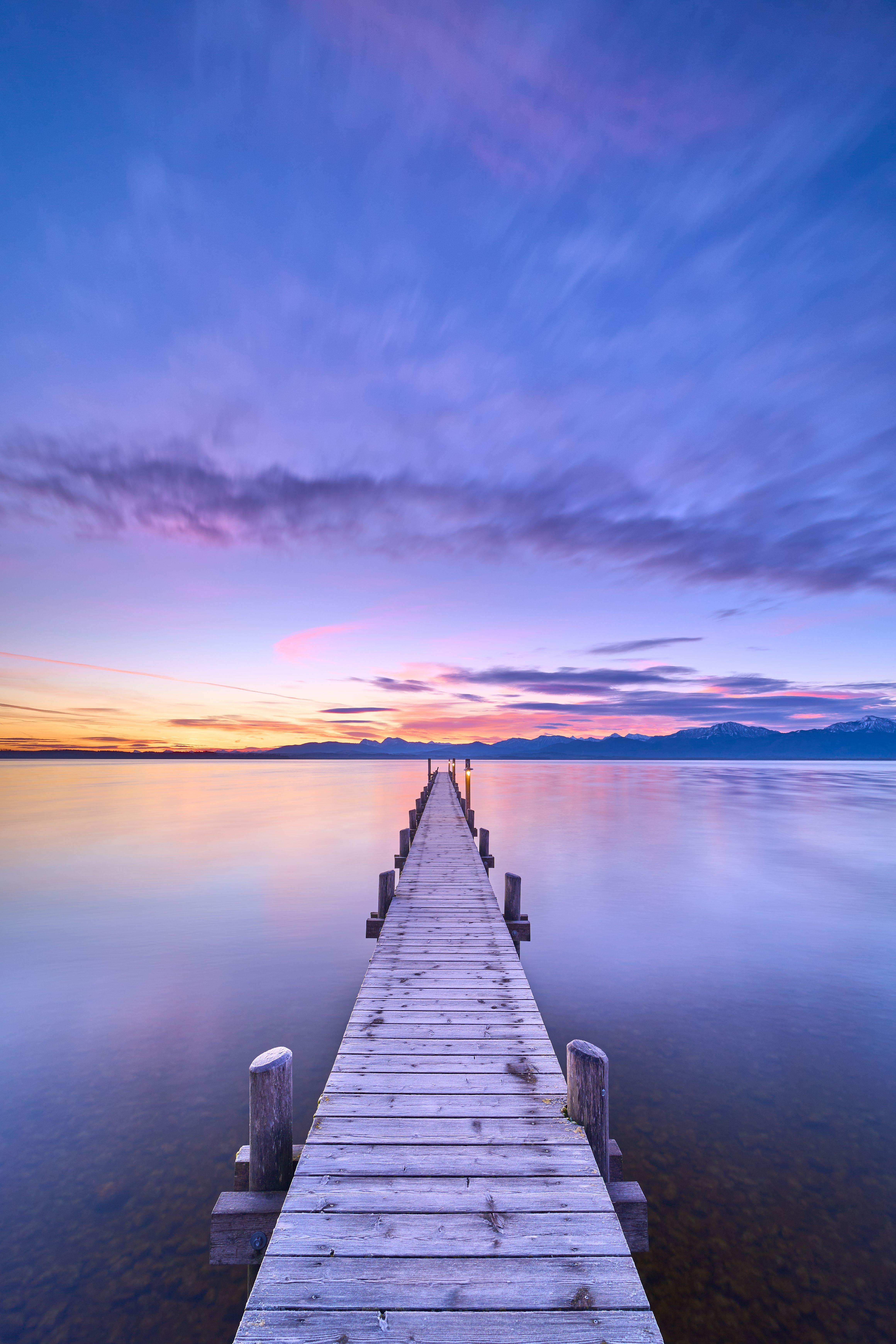 A long wooden pier with a beautiful sunset · Free Stock Photo
