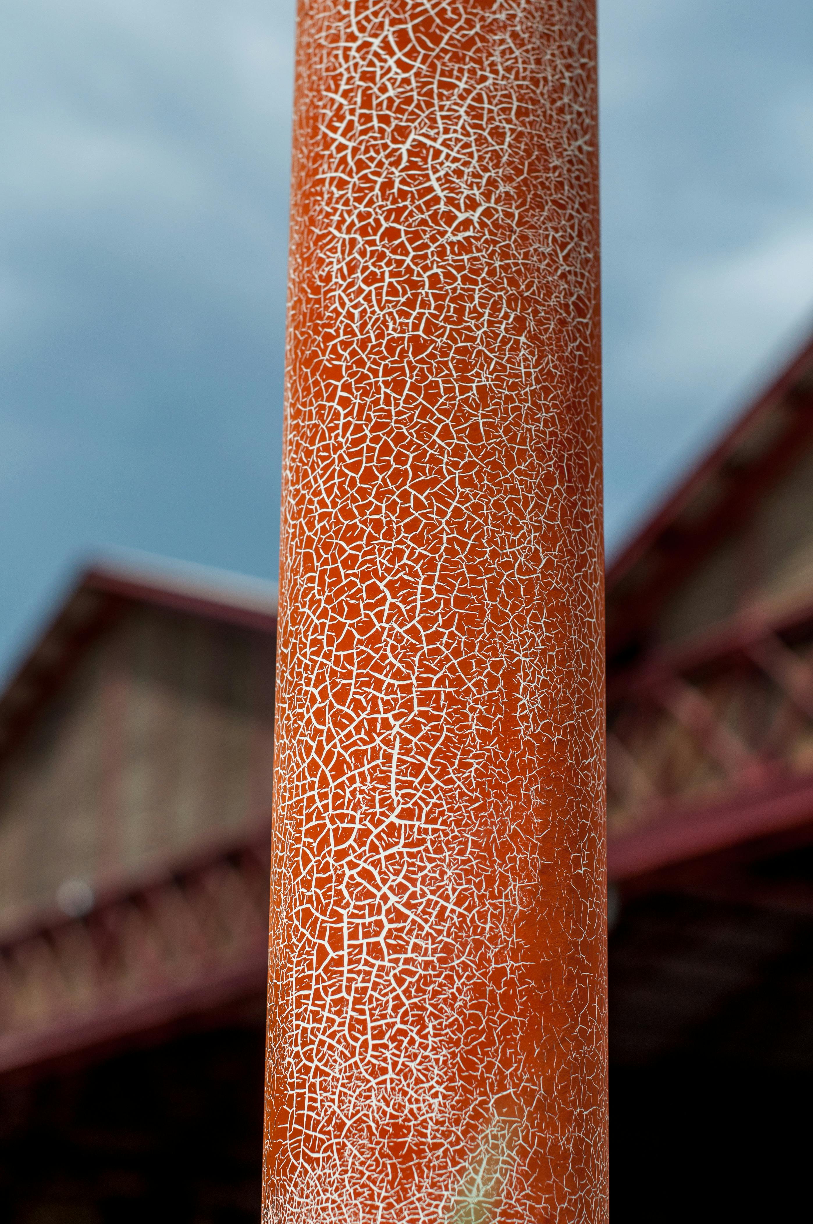 A close up of an orange pole with a red and white stripe · Free Stock Photo