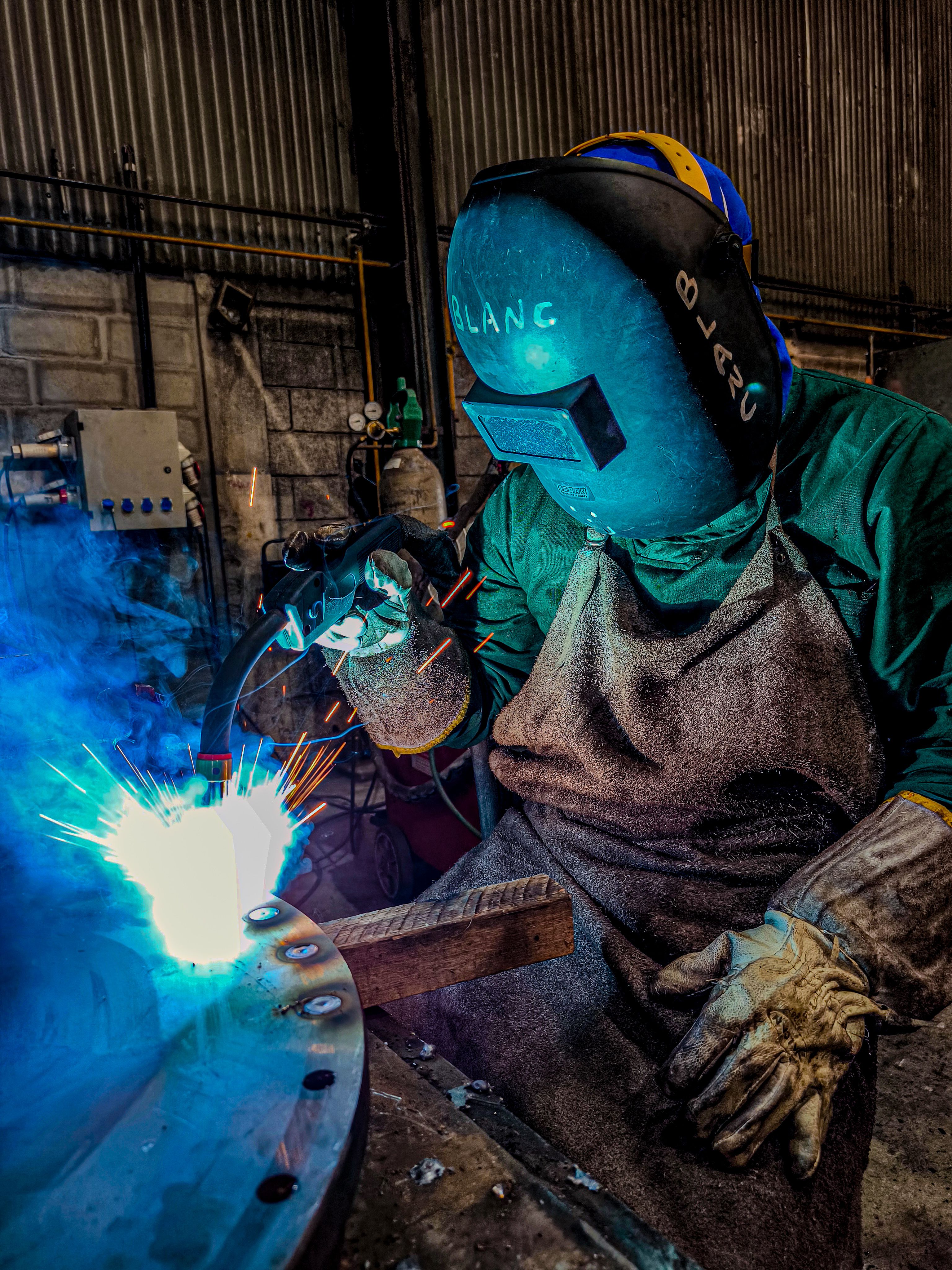 Person Welding Wearing a Prootective Metal Mask · Free Stock Photo