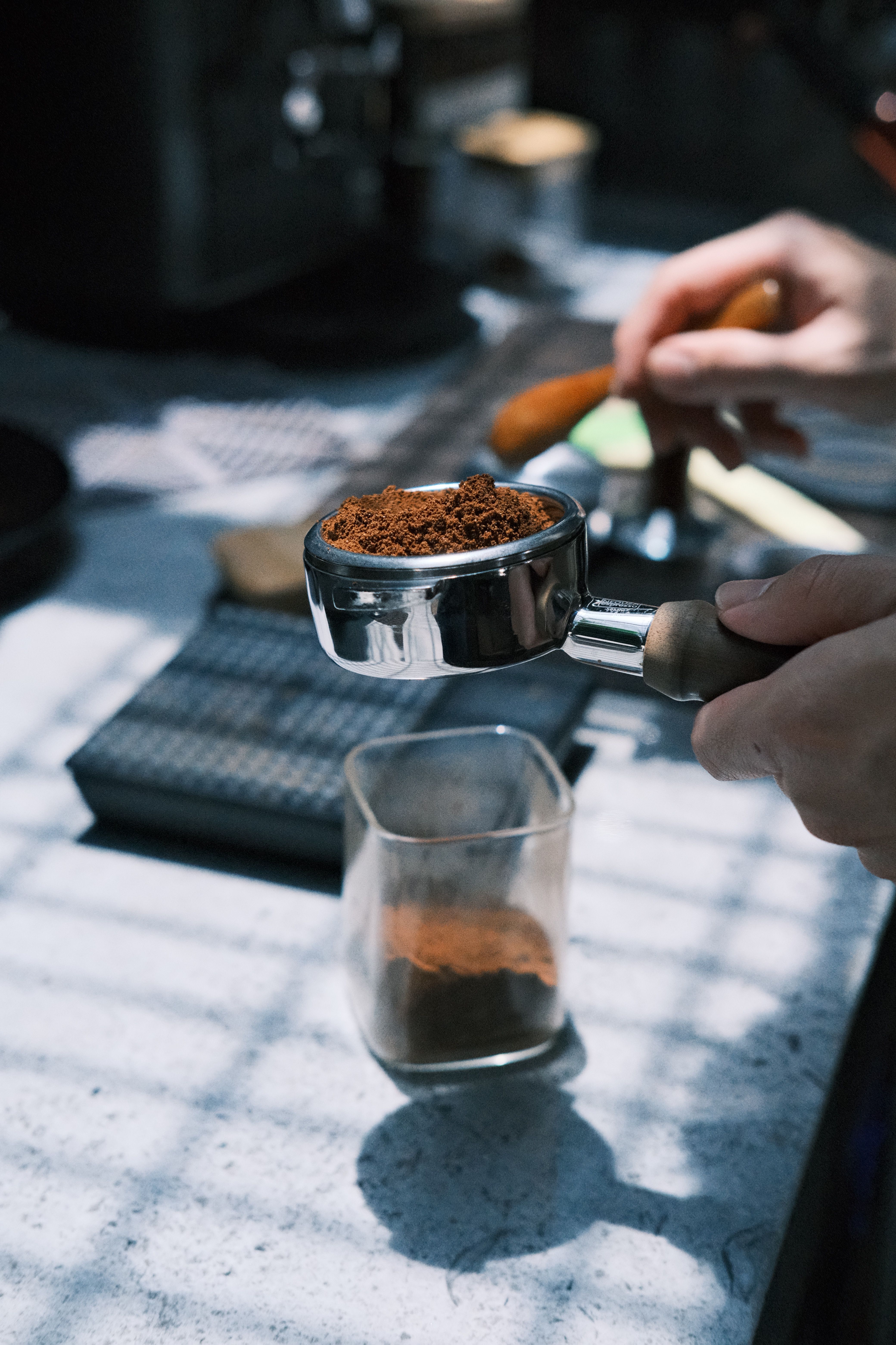 A person is grinding coffee beans in a coffee grinder · Free Stock Photo