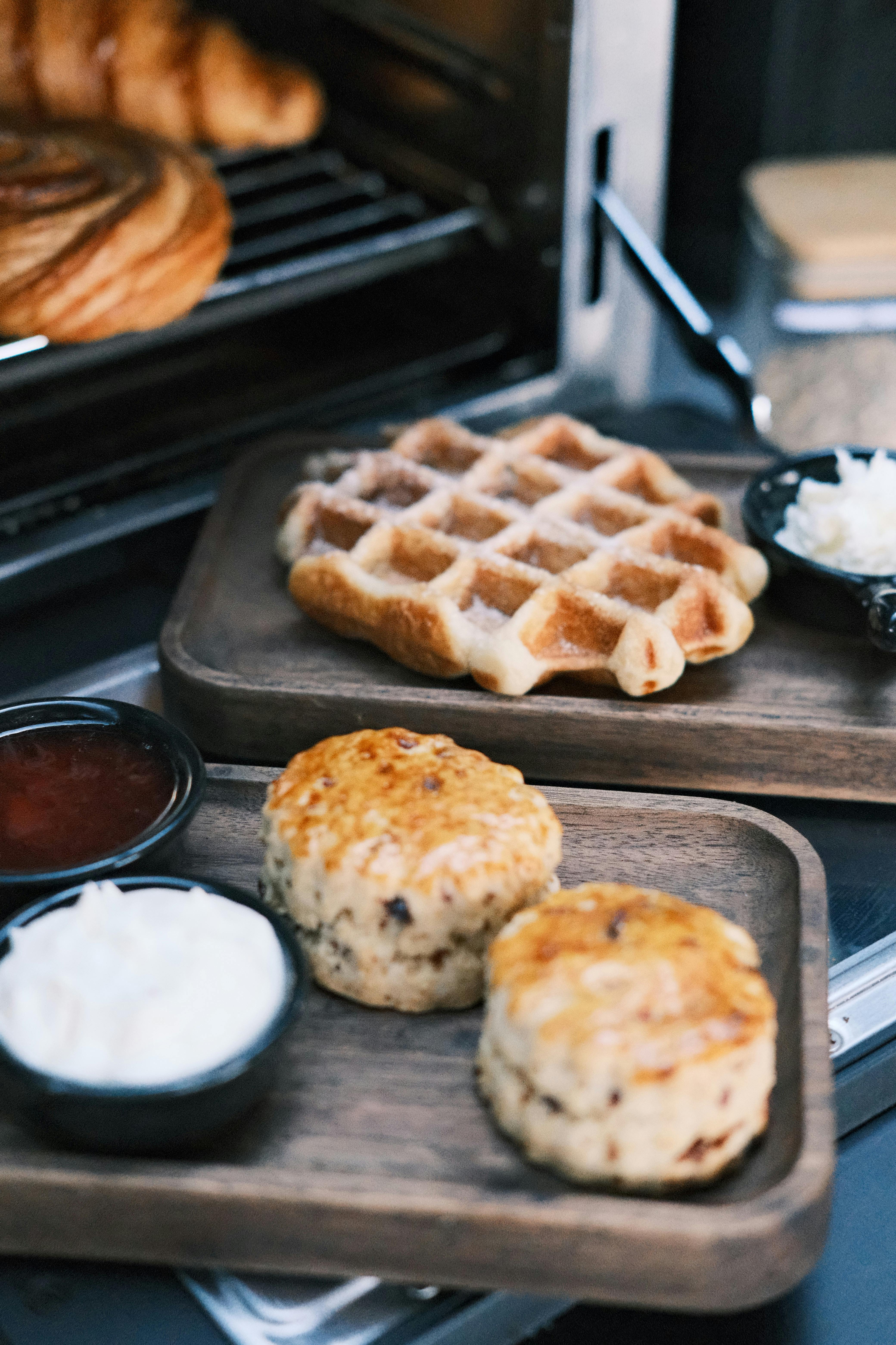 A tray with waffles, eggs and other food · Free Stock Photo